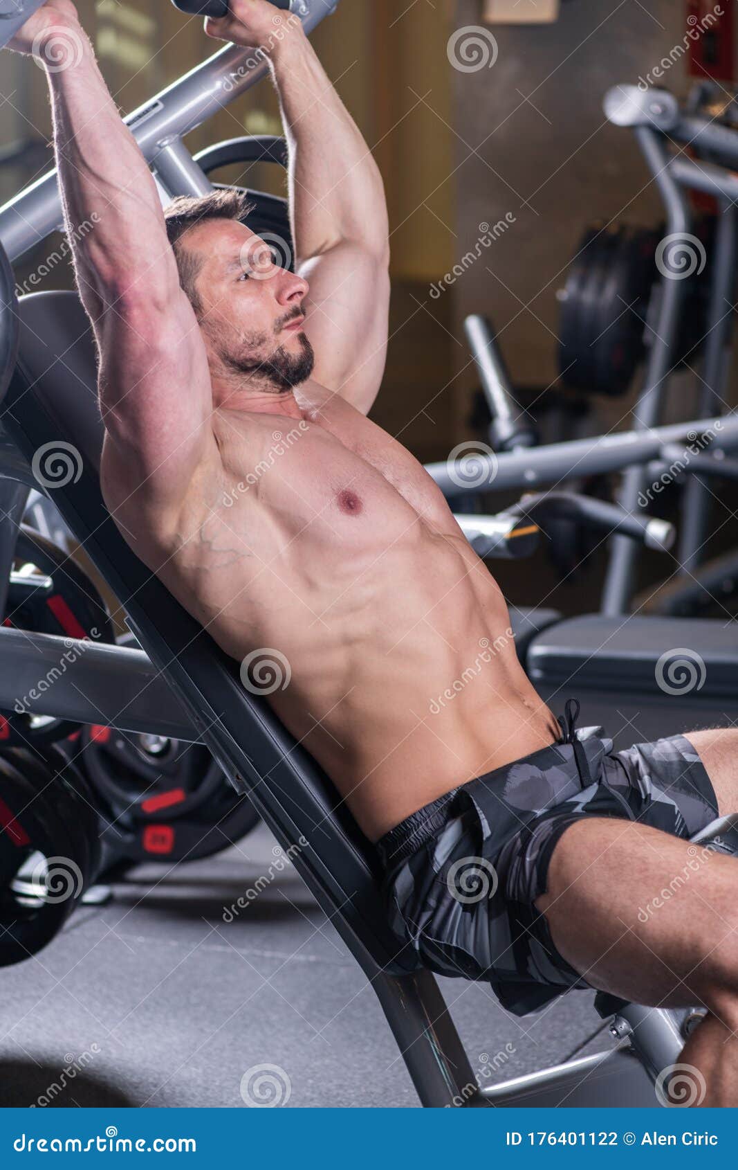 Young Muscular Man Doing Upper Chest Exercise on the Machine. Side View ...