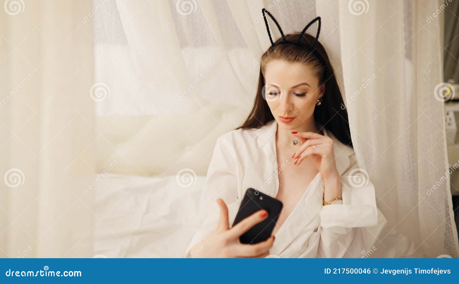 Young Woman In Lingerie And White Shirt Posing Making Selfie On Mobile
