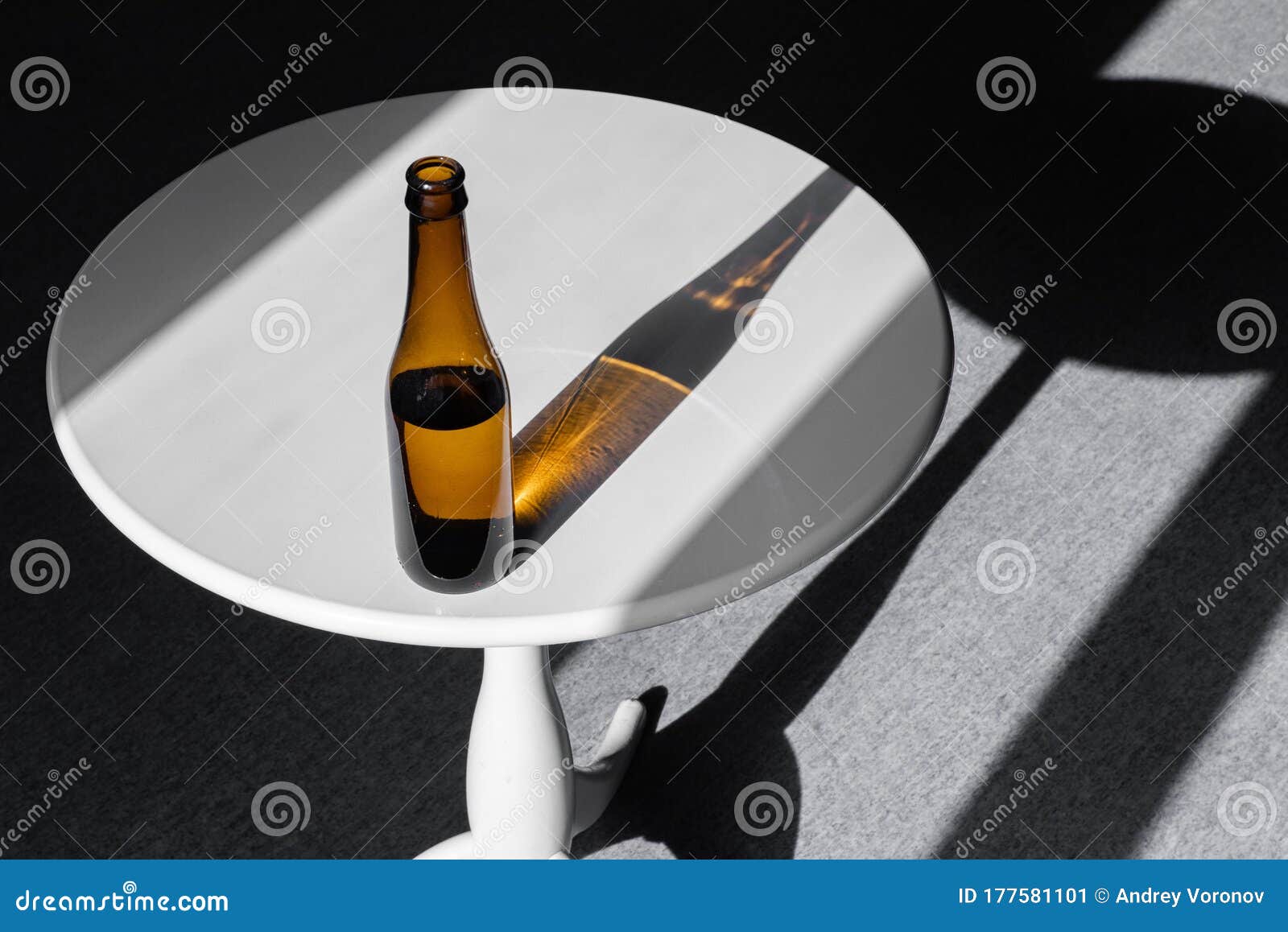 Shadow of Glass Bottle with Liquid on a White Table Stock Image - Image ...