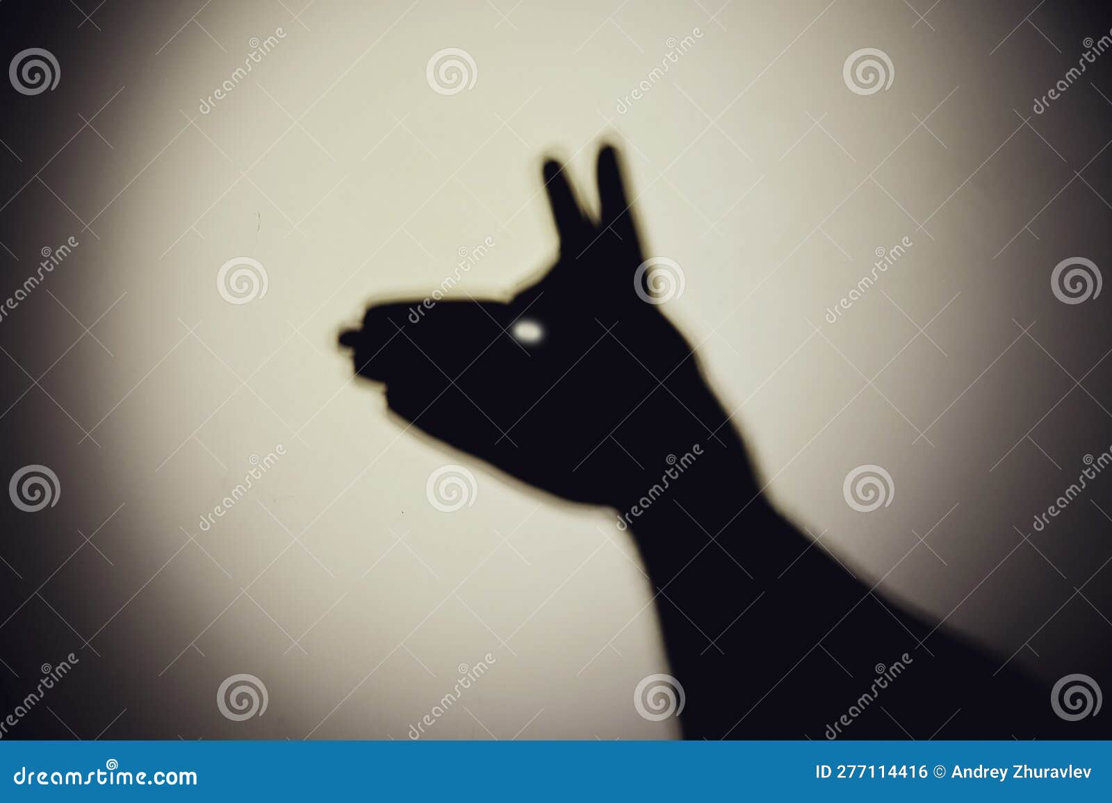 Shadow of a Hand from the Night Light of a Flashlight on a White Wall ...