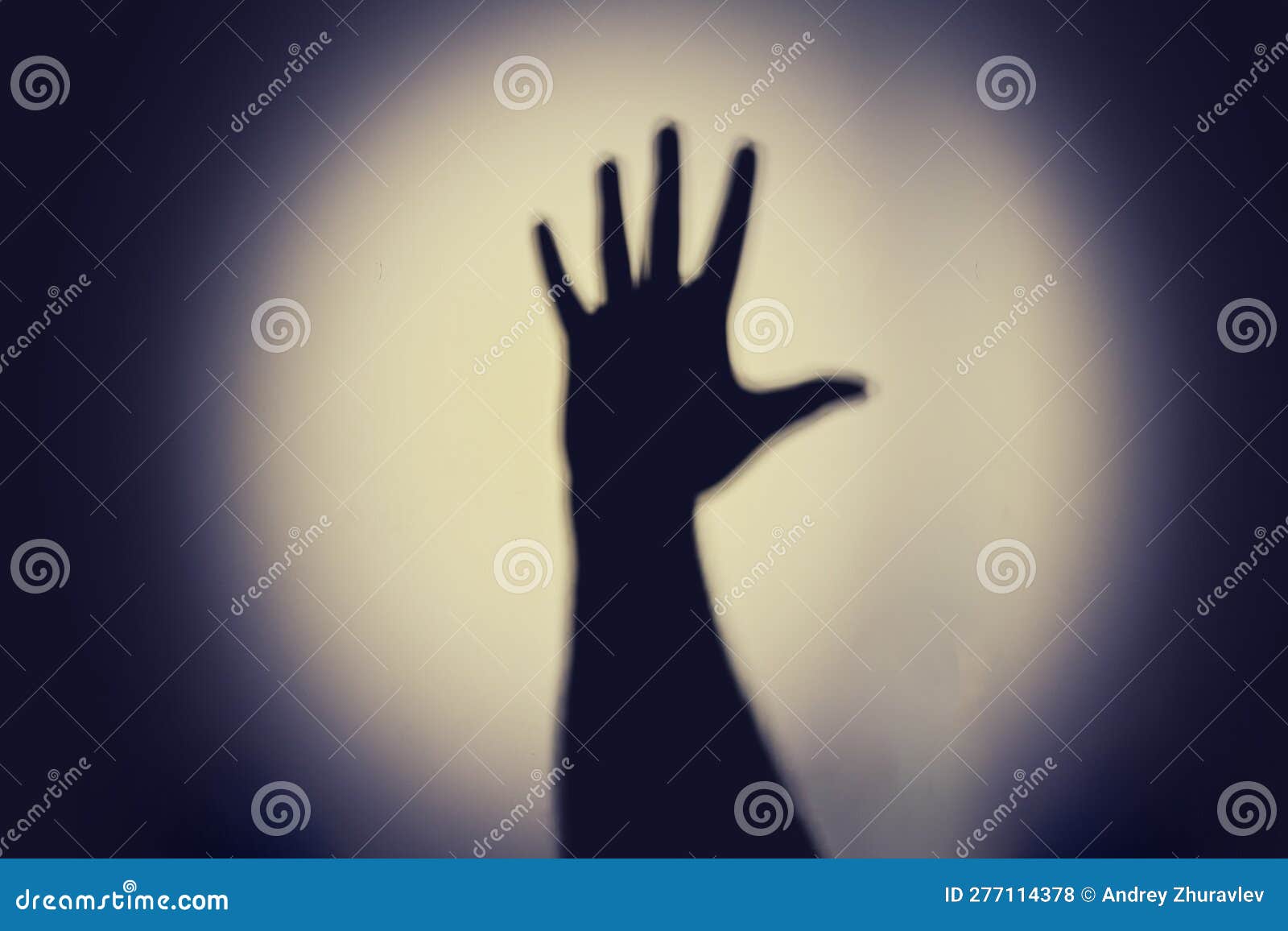 Shadow of a Hand from the Night Light of a Flashlight on a White Wall ...