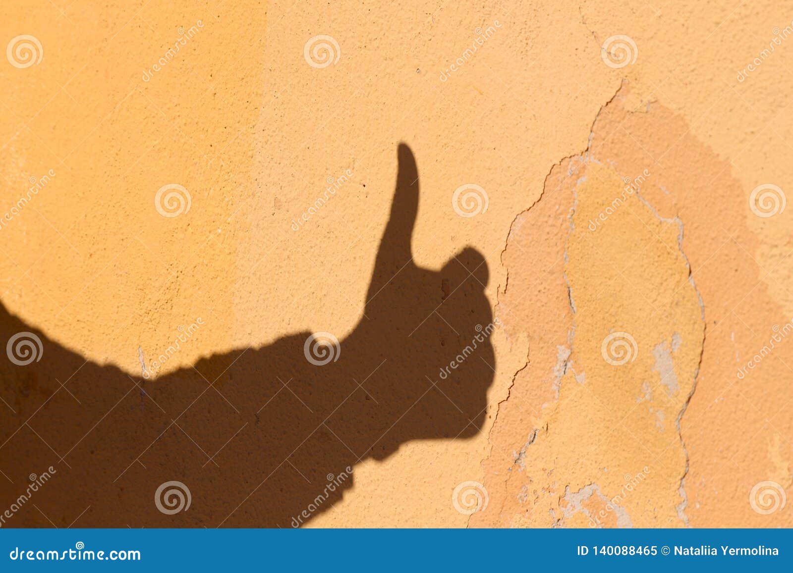 Shadow of a Hand with a Thumb Up on the Background of an Old Yellow ...