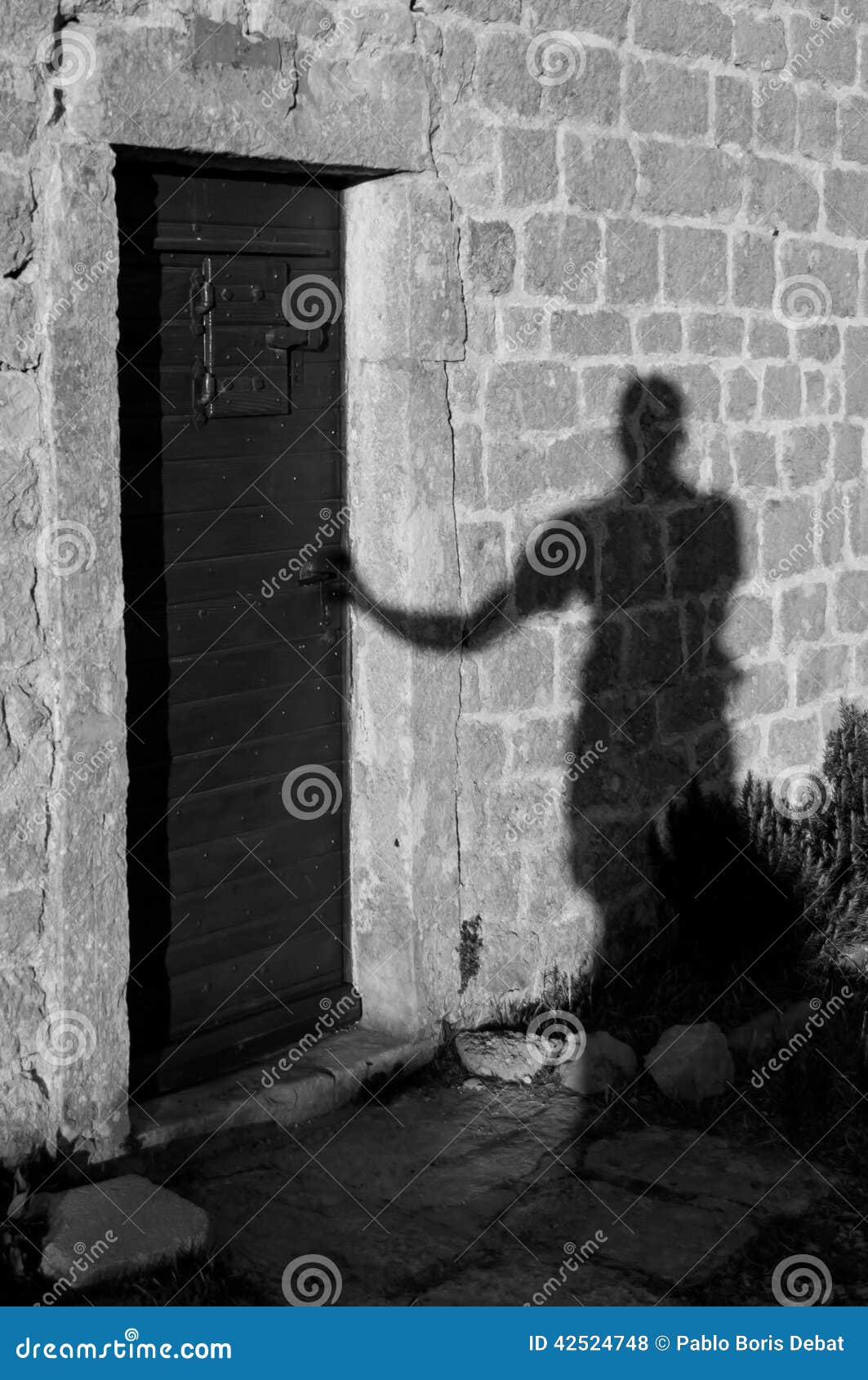 Shadow of Man Opening Door at Lubenice B&W Stock Photo - Image of blue ...