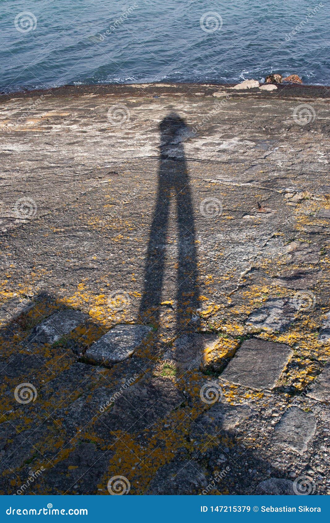 Shadow Man in a Sea Shore Rock Stock Image - Image of assignment ...
