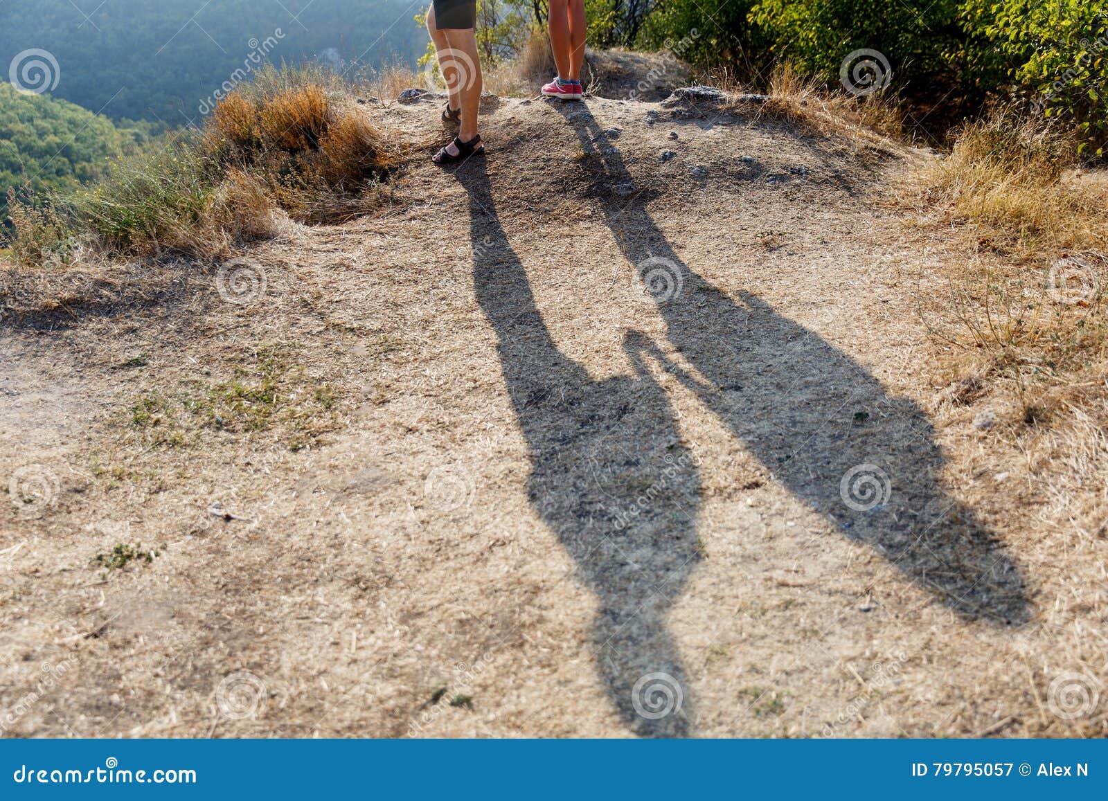 Shadow of People Holding Hands on Hill with Dry Grass Stock Image ...