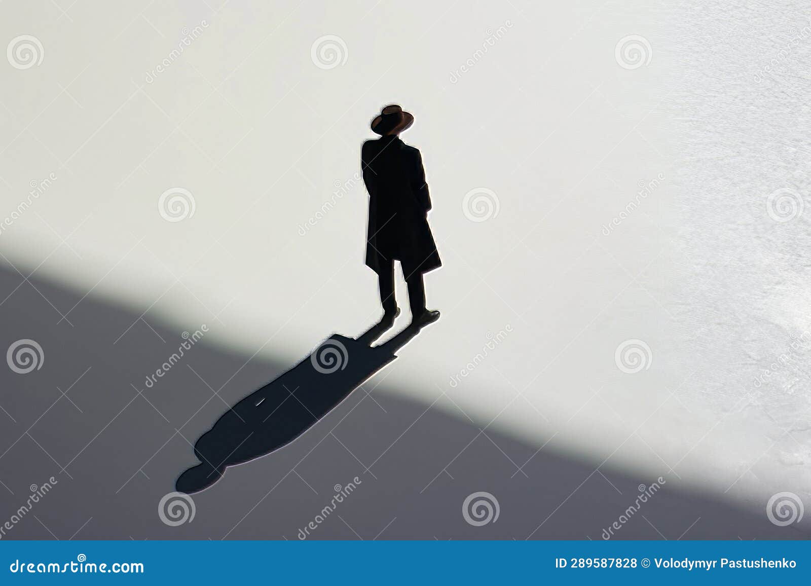 Shadow of Person in Hat and Coat Standing in the Shadows of Wall ...