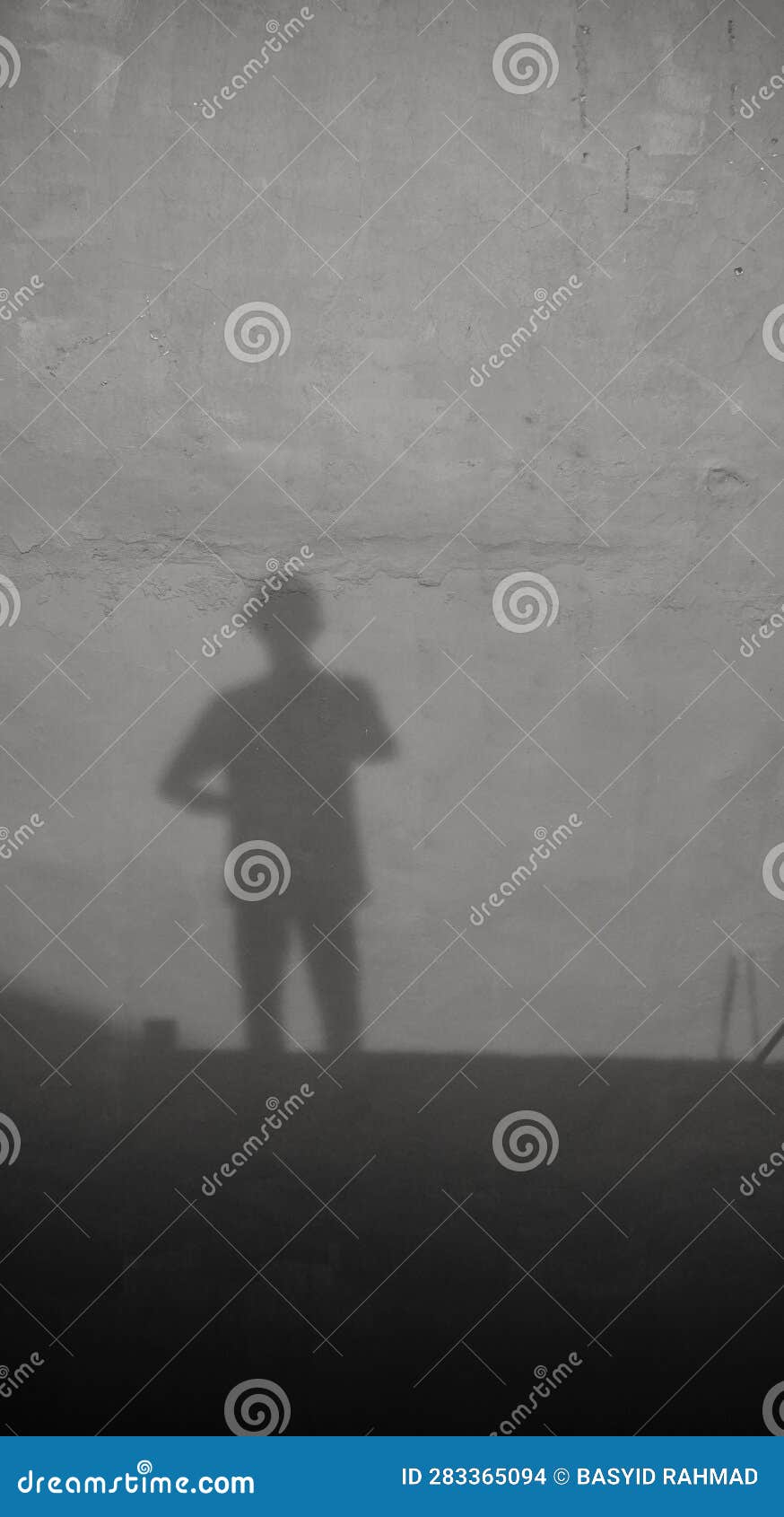 The Shadow of a Person Wearing a Hat is Visible on the Wall Stock Photo ...