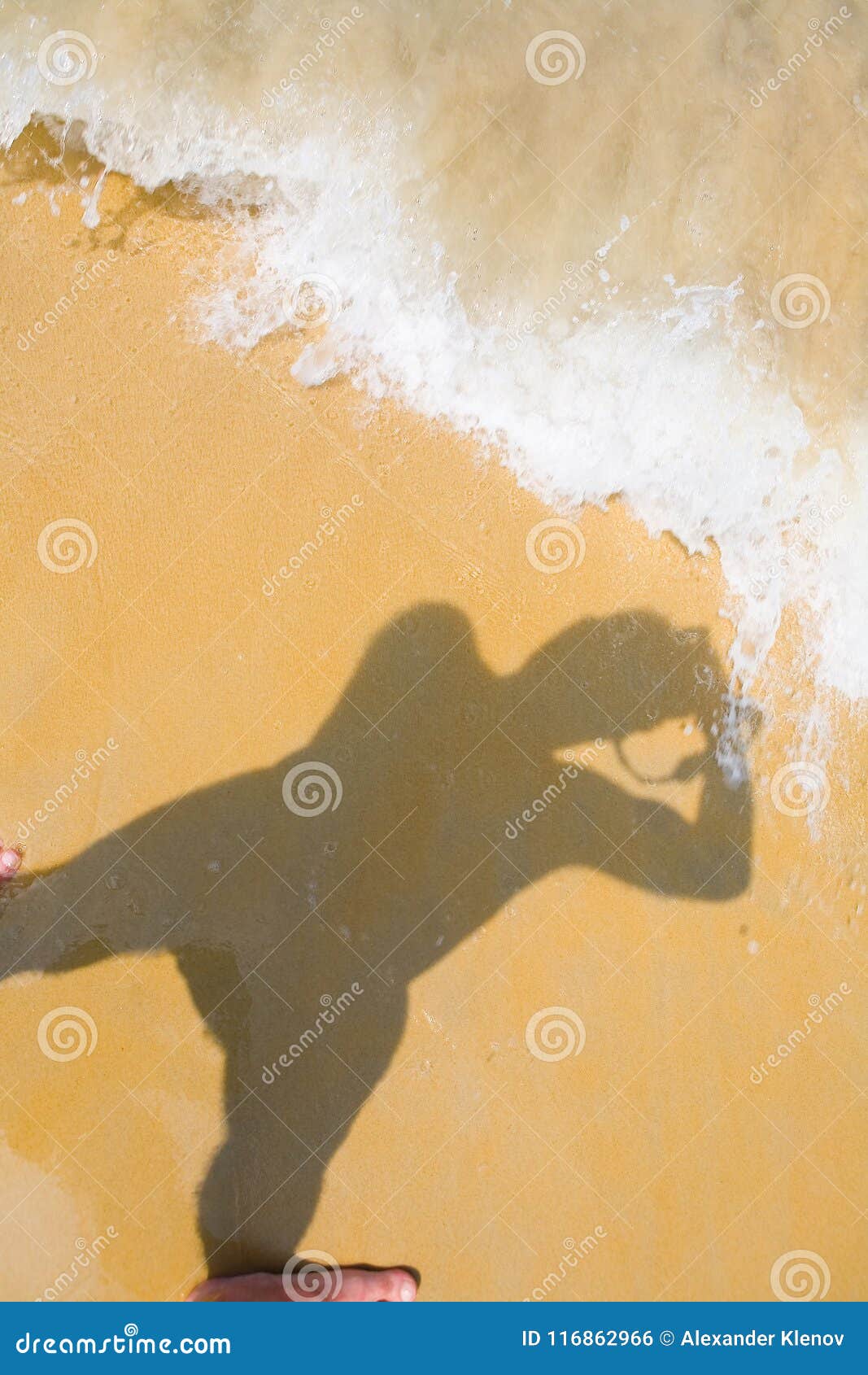 The Shadow of the Photographer on the Beach and the Wave. Stock Photo ...