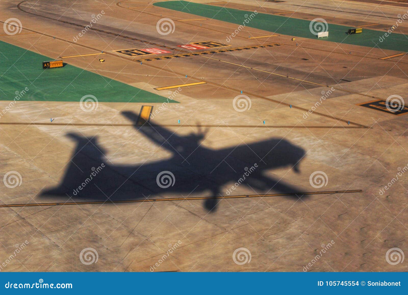 Shadow of a plane landing stock photo. Image of aerial - 105745554