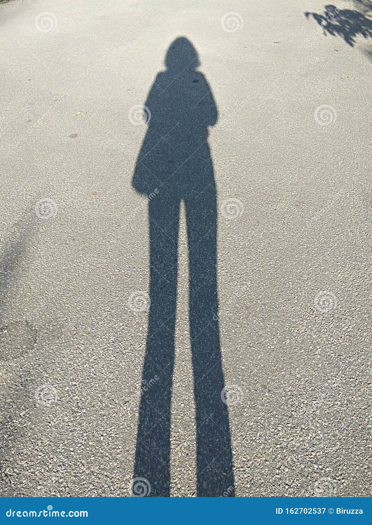 Shadow of a Tall Girl on an Asphalt Road. Stock Image - Image of blur ...