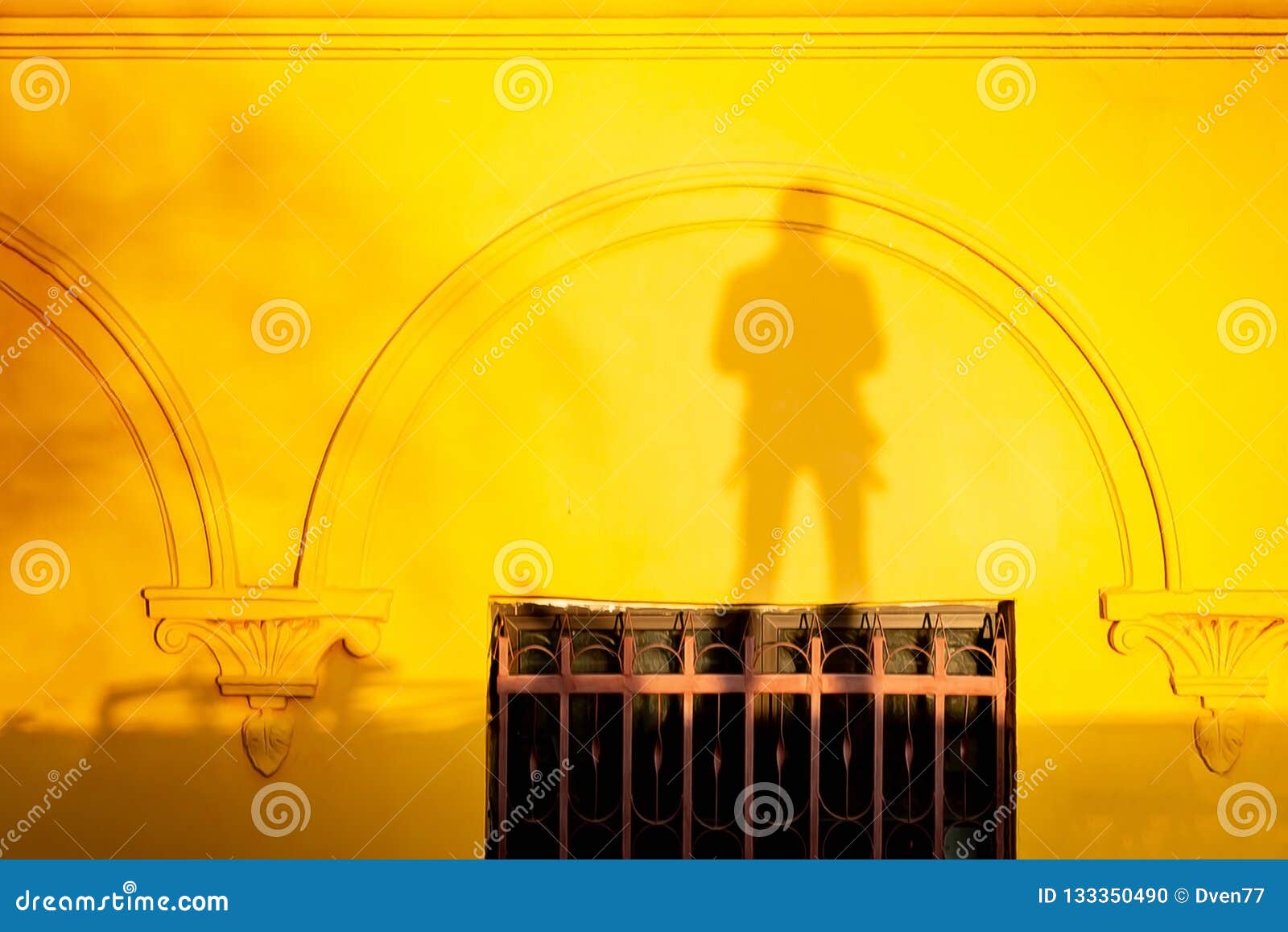 Shadow of an Unknown Man on the Yellow Wall Stock Photo - Image of ...