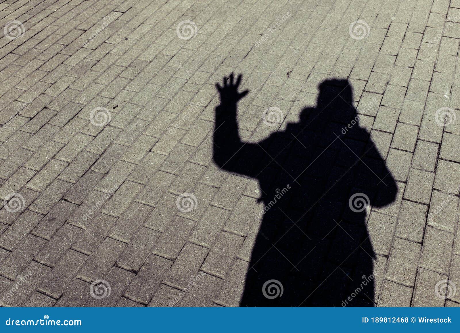 Shadow of a Waving Person Cast on the Tiles of the Ground Stock Photo ...
