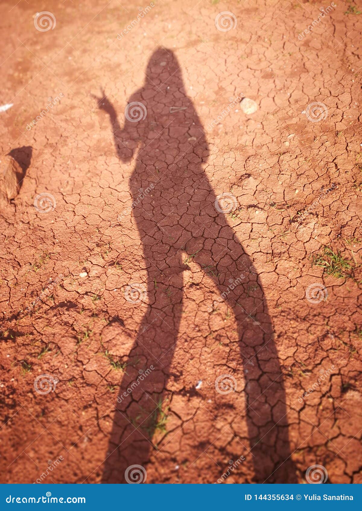 The Shadow of the Woman on the Dry Clay Surface of the Ground Stock ...