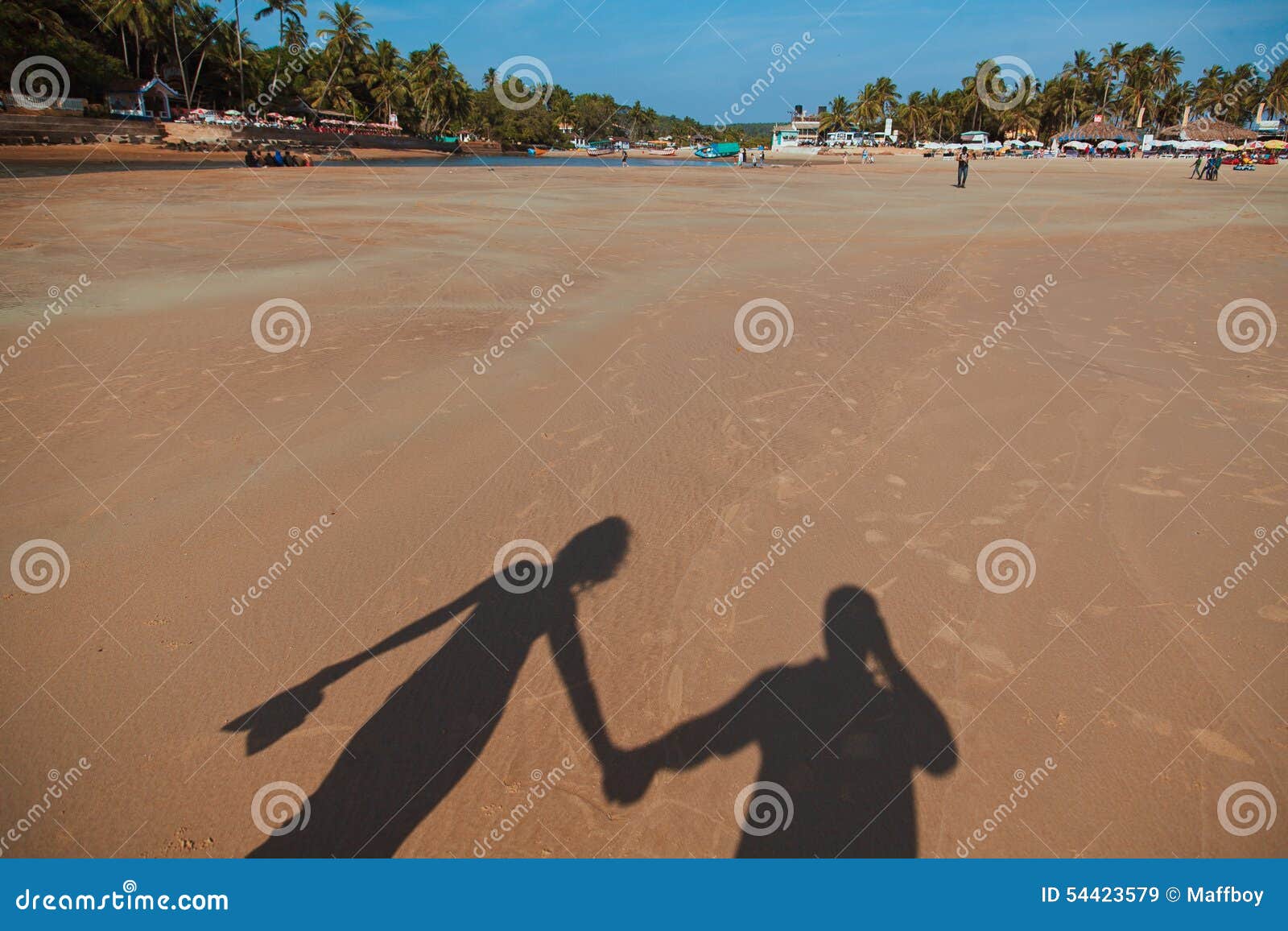 Shadows on the beach stock image. Image of companionship - 54423579