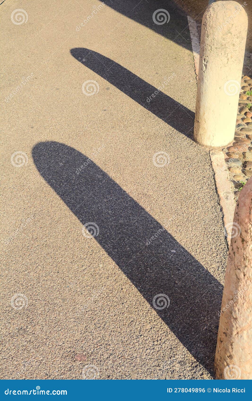 Shadows Casted by Stone Pillars on a Pavement at Sunset Stock Photo ...