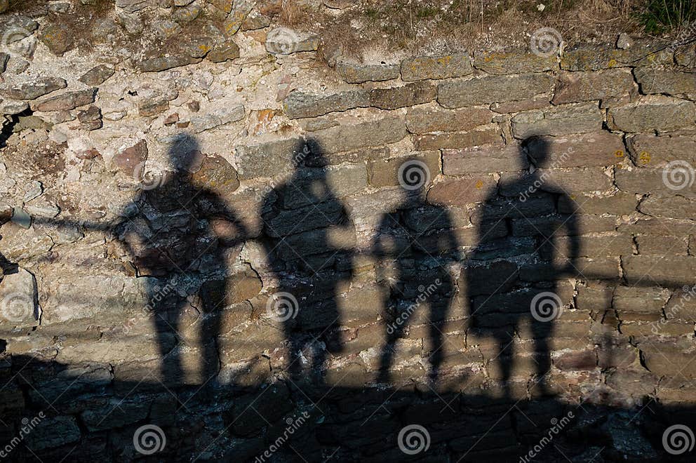 Shadows from Four People on the Wall Stock Photo - Image of shape ...