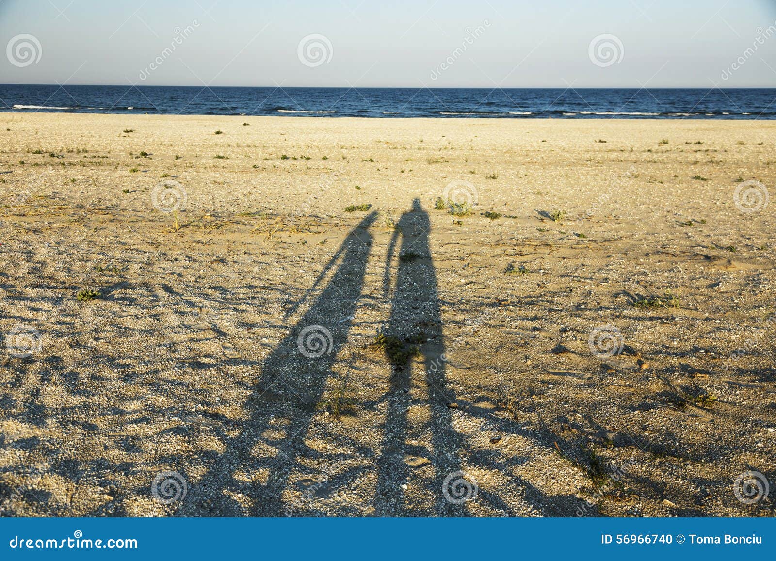 Shadows of loving couple stock photo. Image of beach - 56966740