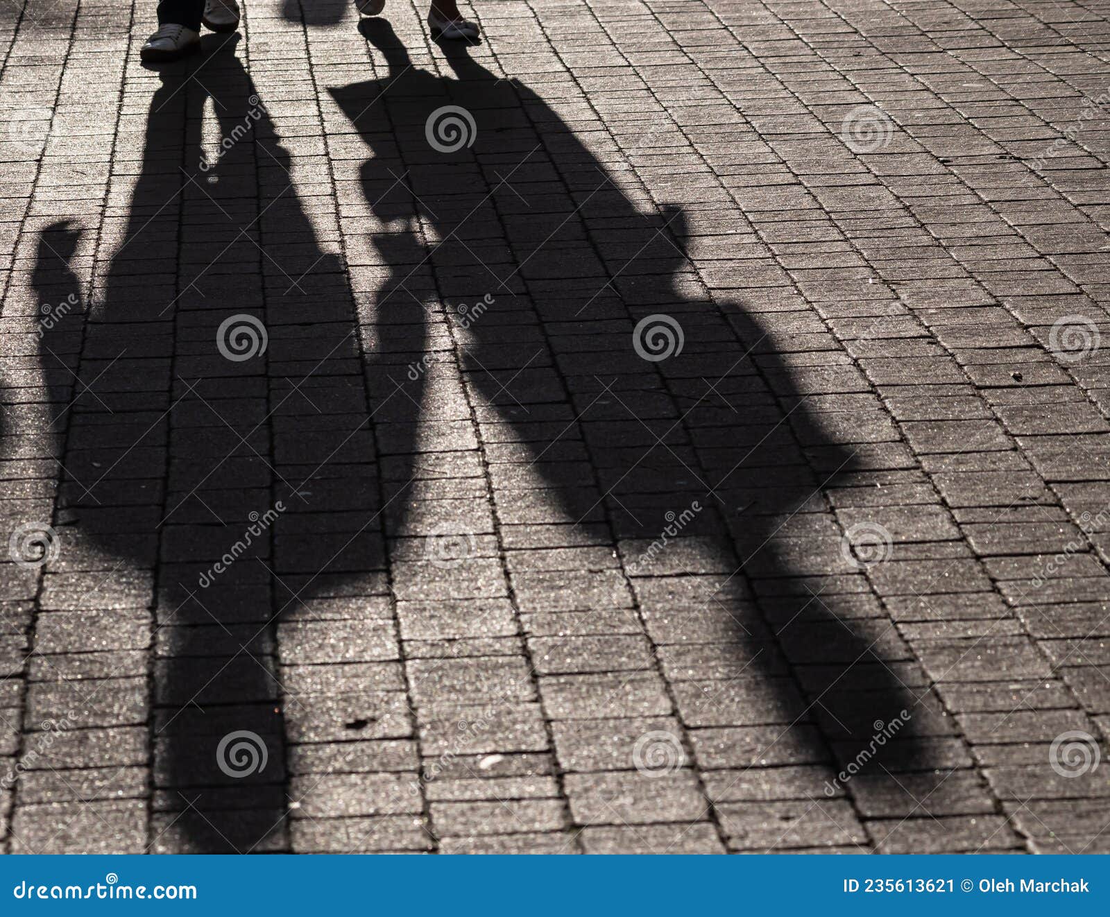 Shadows on Pavement of Two People Walking Under Bright Sunlight Stock ...