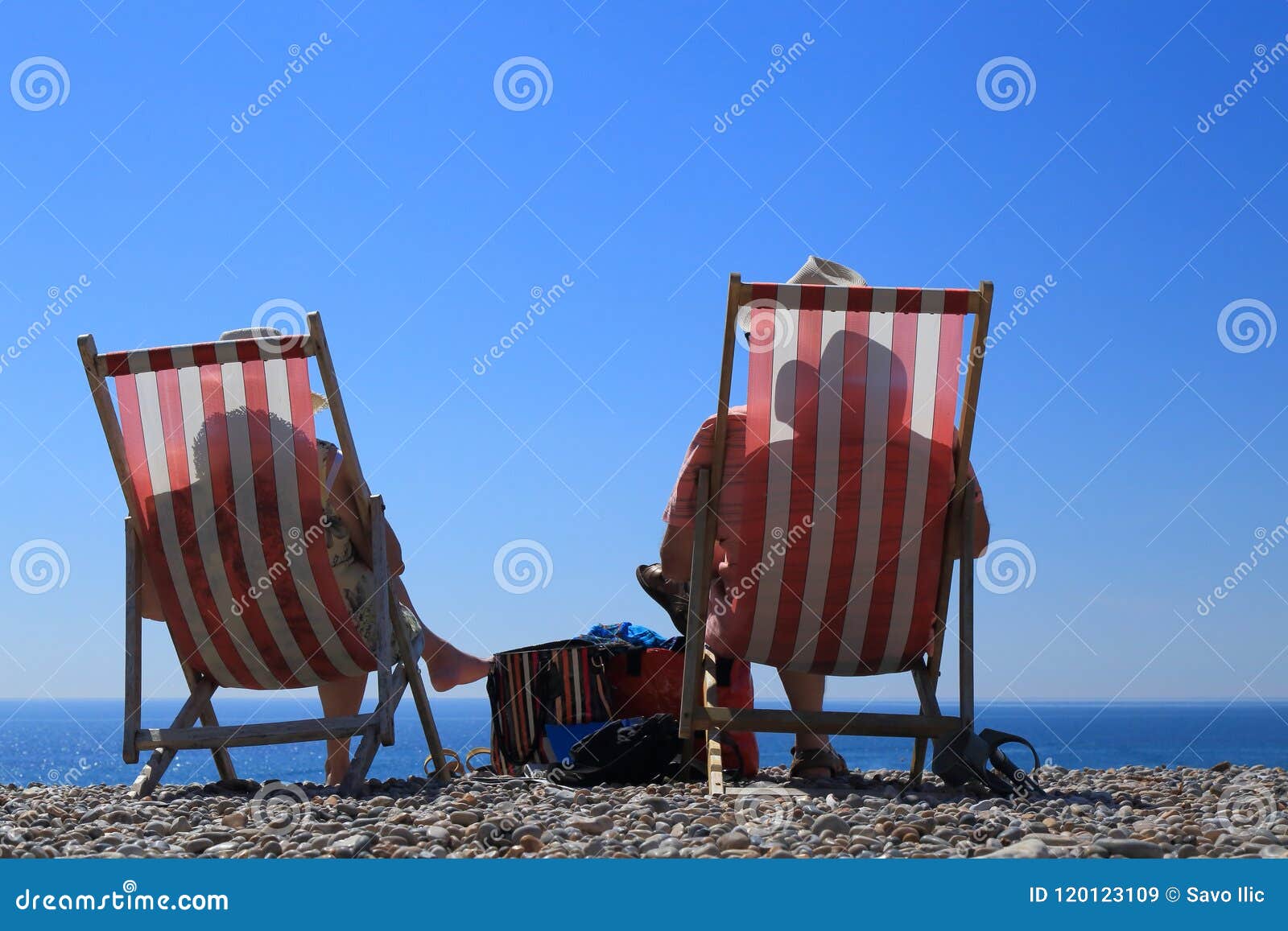 Shadows of People Sitting on Deck Chairs Stock Image - Image of pebble ...