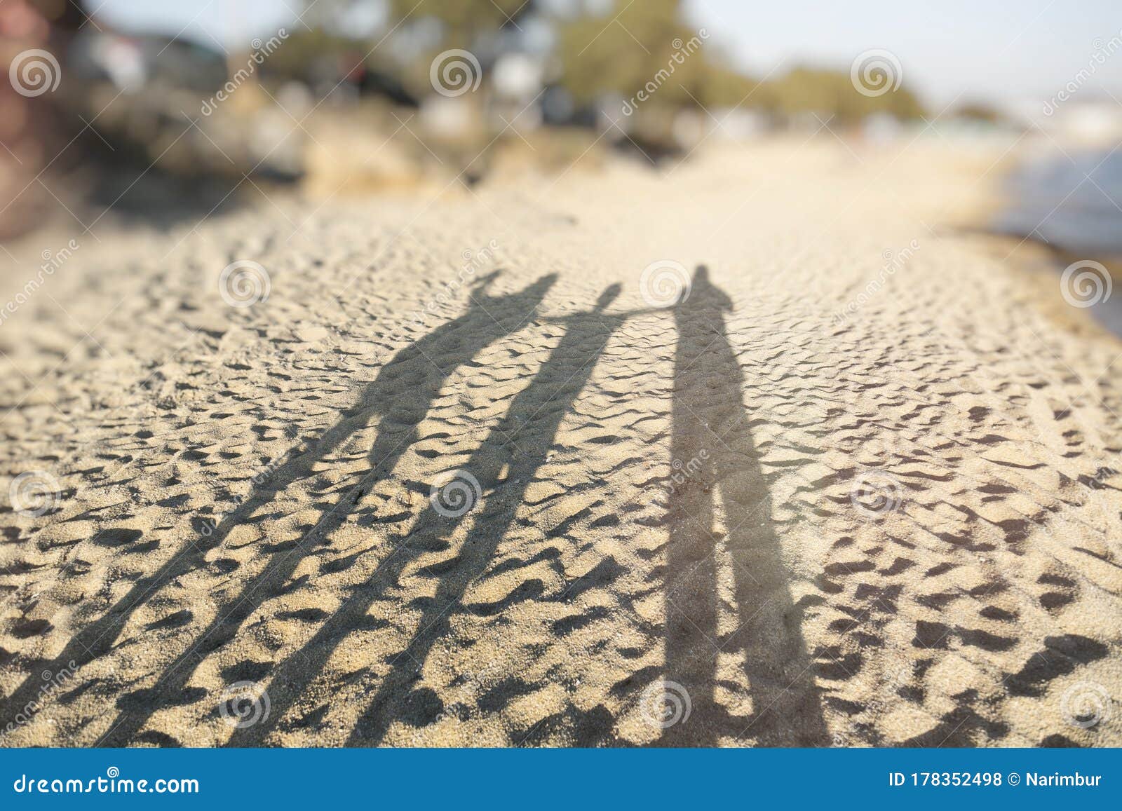 Shadows of Three People on a Beach Stock Photo - Image of lifestyle ...
