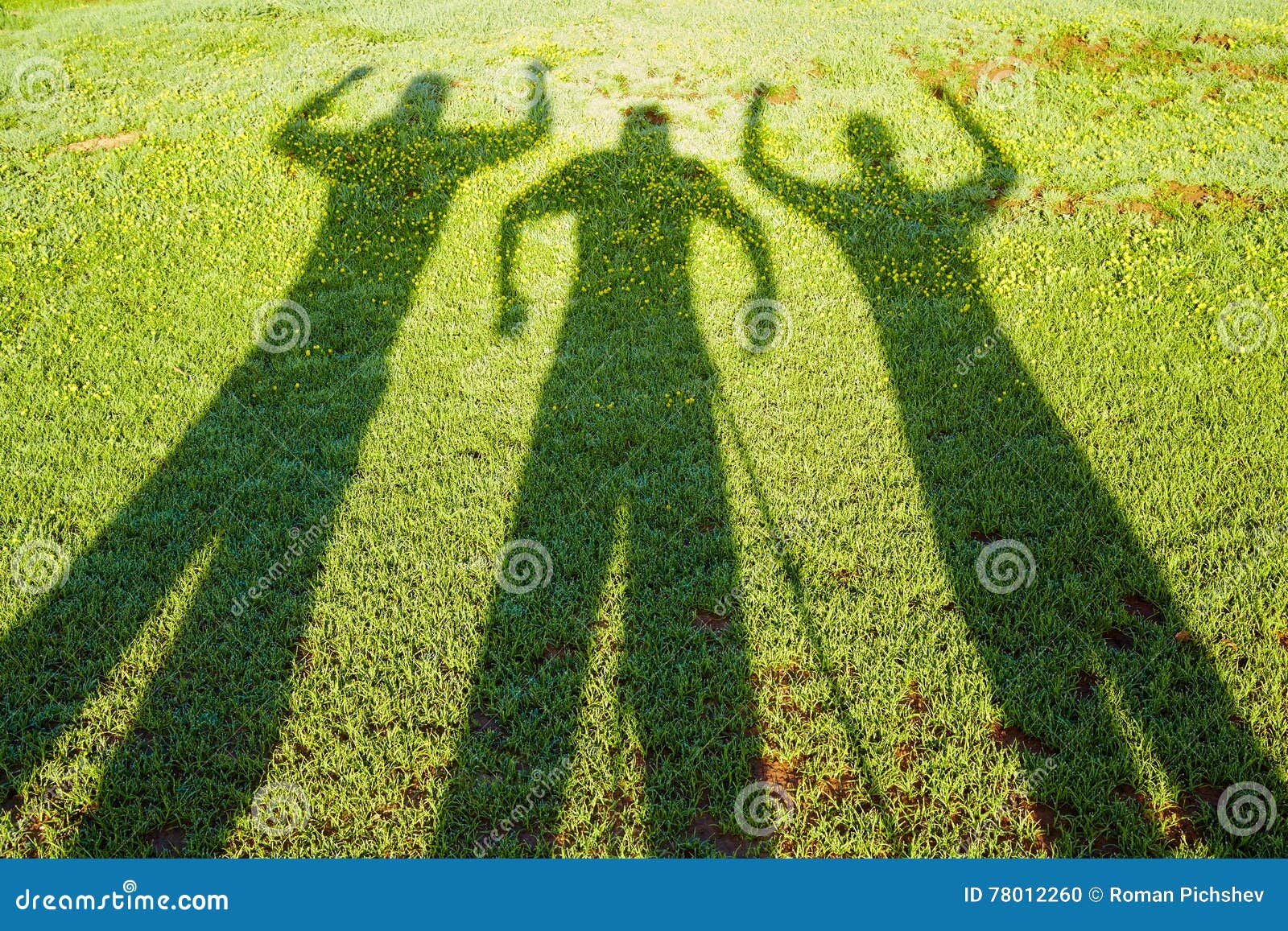 Shadows from Three People on a Grass Stock Photo - Image of field ...