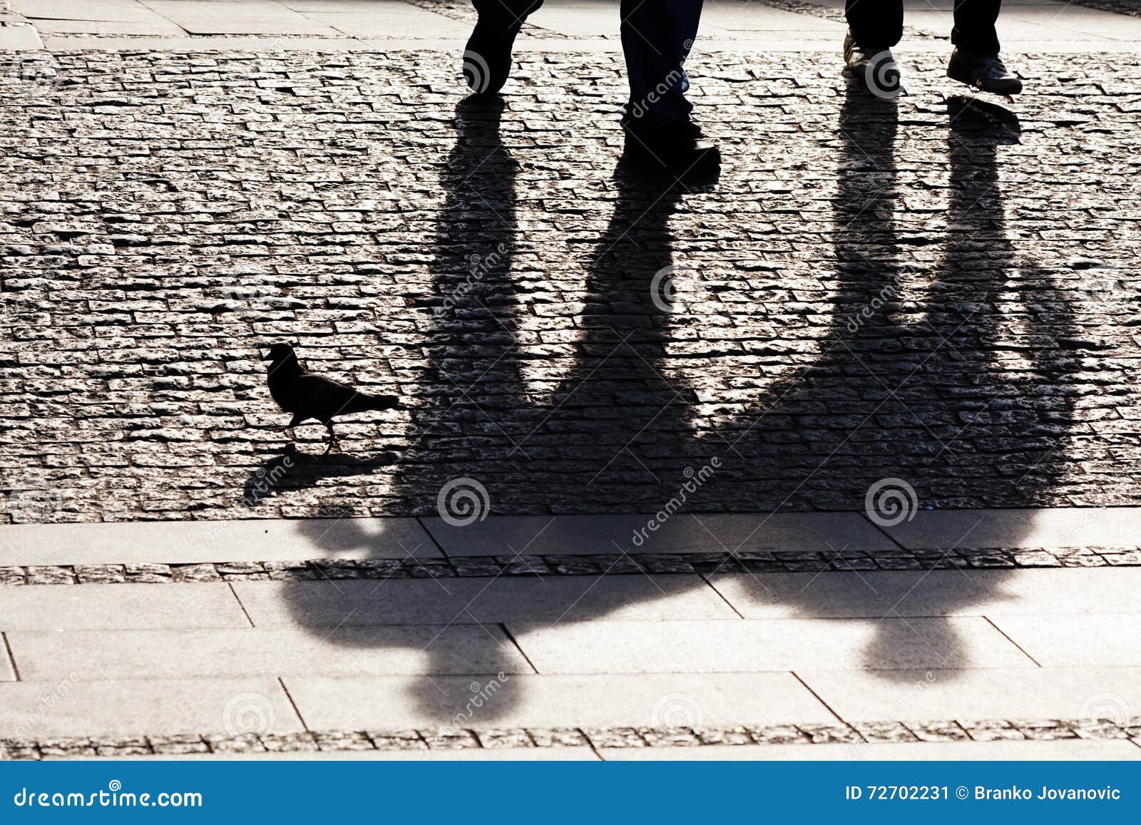 Shadows of two man walking stock image. Image of sidewalk - 72702231