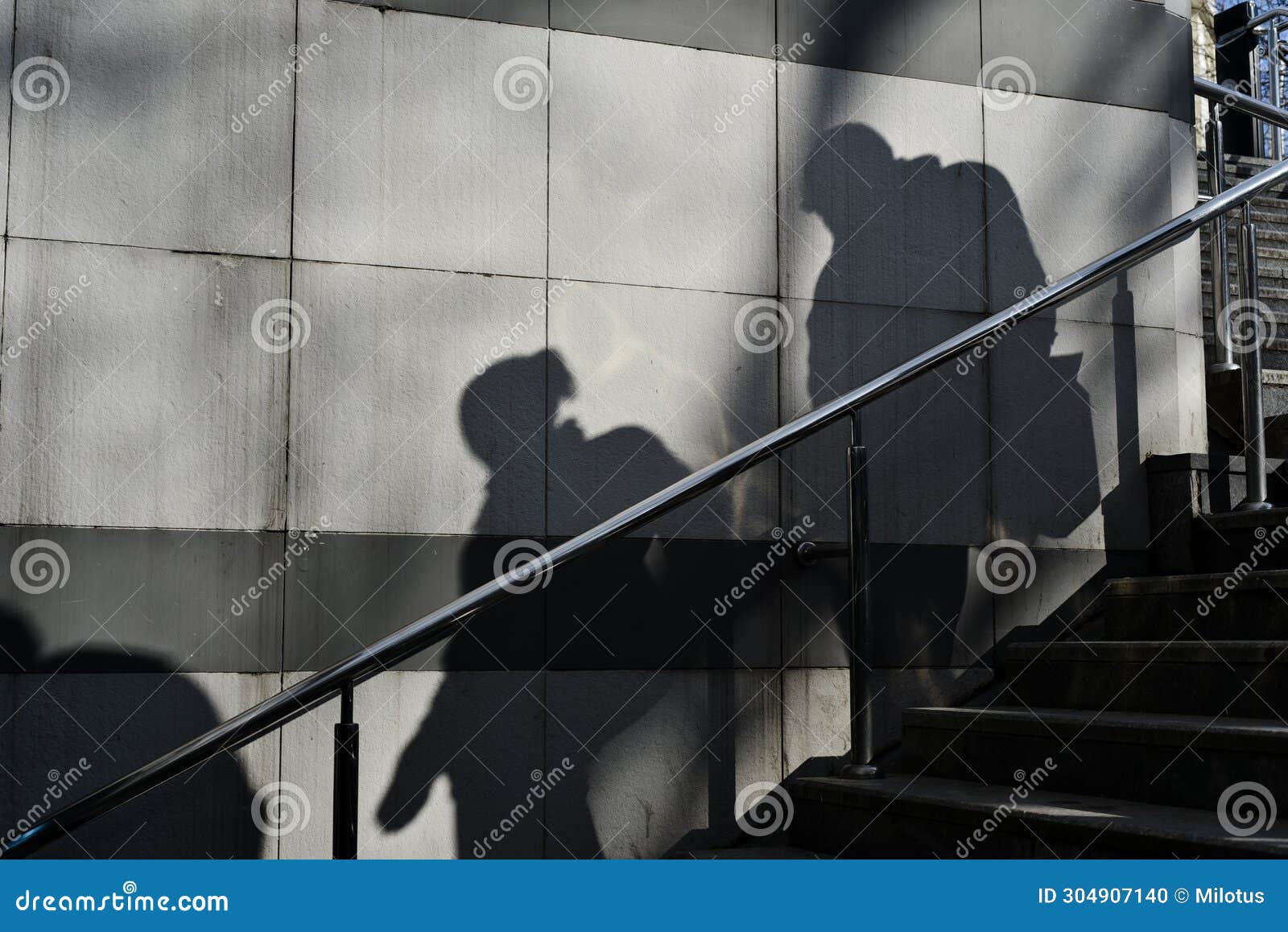Shadows on the Wall of Two Men Coming Down the Steps Stock Photo ...