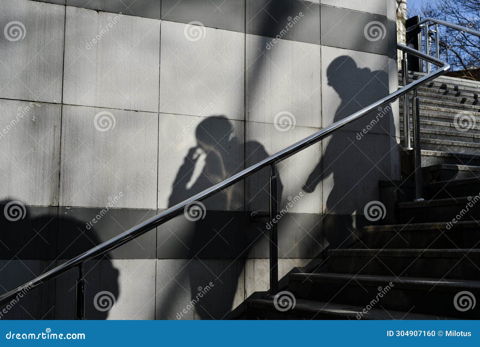 Shadows on the Wall of Two Men Coming Down the Steps Stock Photo ...