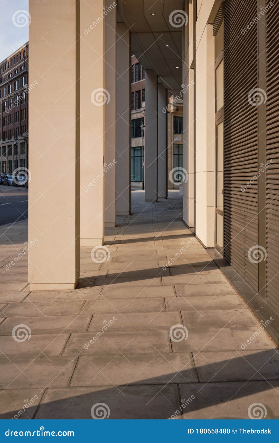 Shadowy City Walkway Next To Modern Building at Night Stock Photo ...