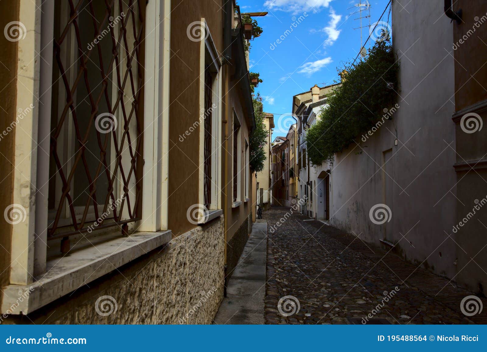 Shady Street in a European Town Bordered by Tall Buildings Stock Photo ...