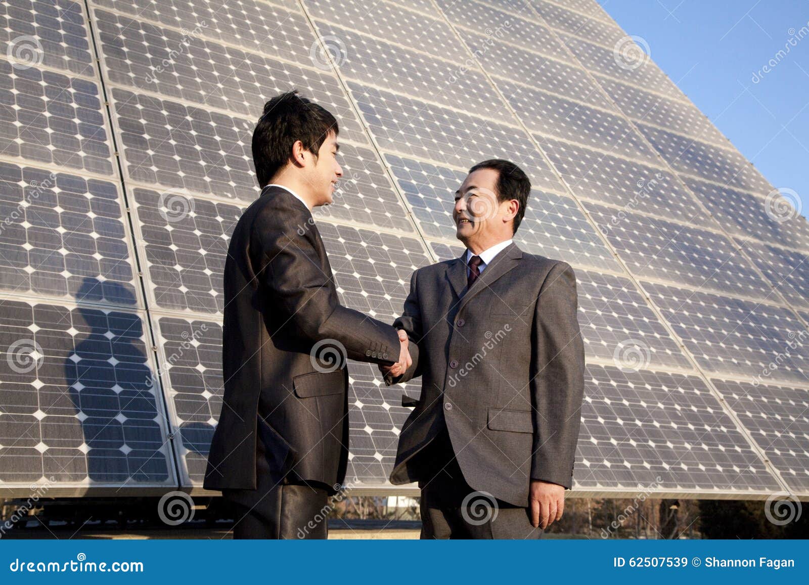 Shaking Hands in Front of Solar Panels Stock Image - Image of asia ...