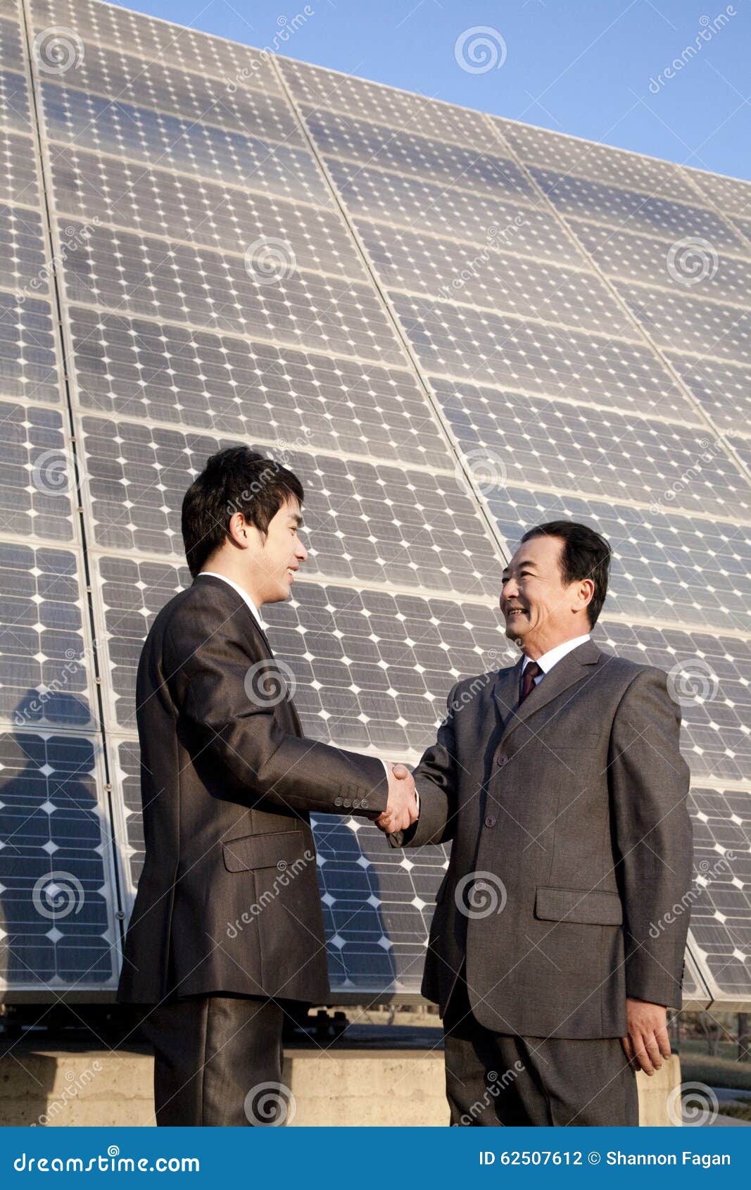 Shaking Hands in Front of Solar Panels Stock Photo - Image of ...