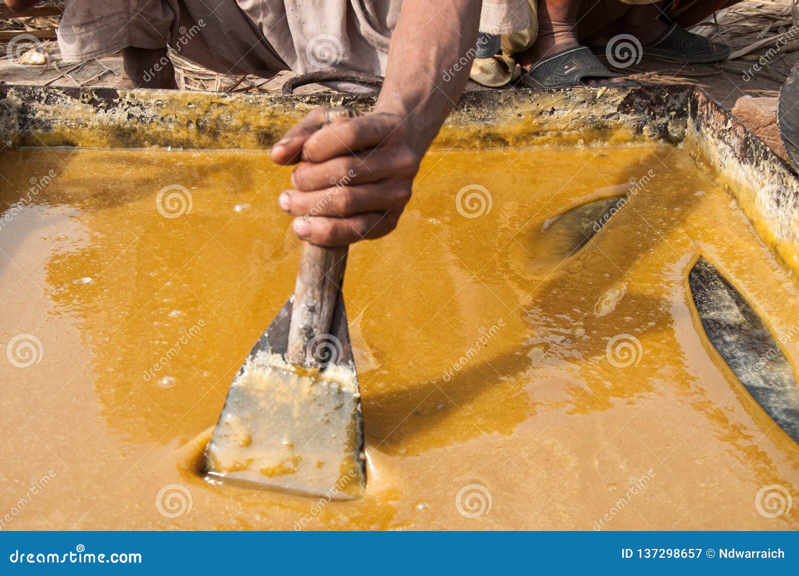 Farmer is making jaggery stock image. Image of candytraditional - 137298657