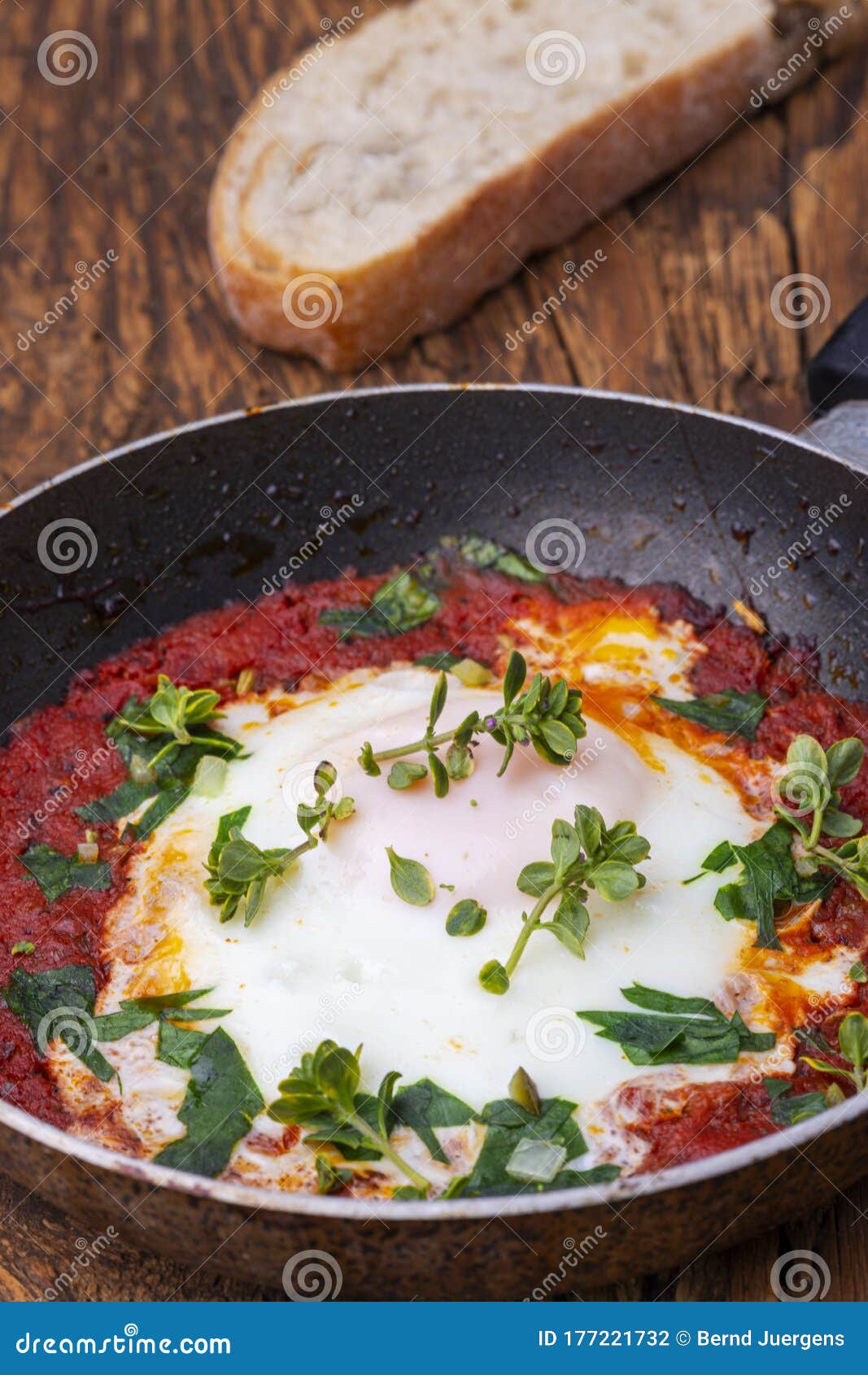 Shakshuka in a pan stock photo. Image of herb, cuisine - 177221732