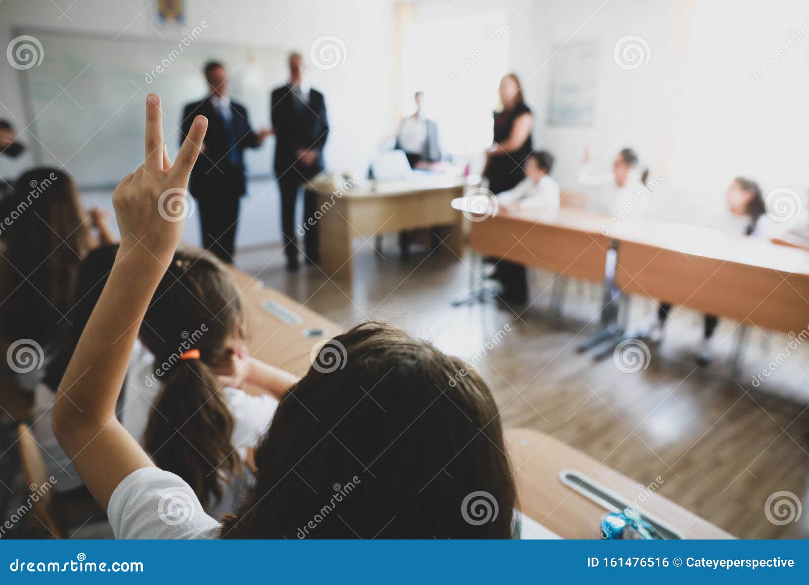 Shallow Depth of Field Image with a Pupil Raised Hand To Answer or Put ...
