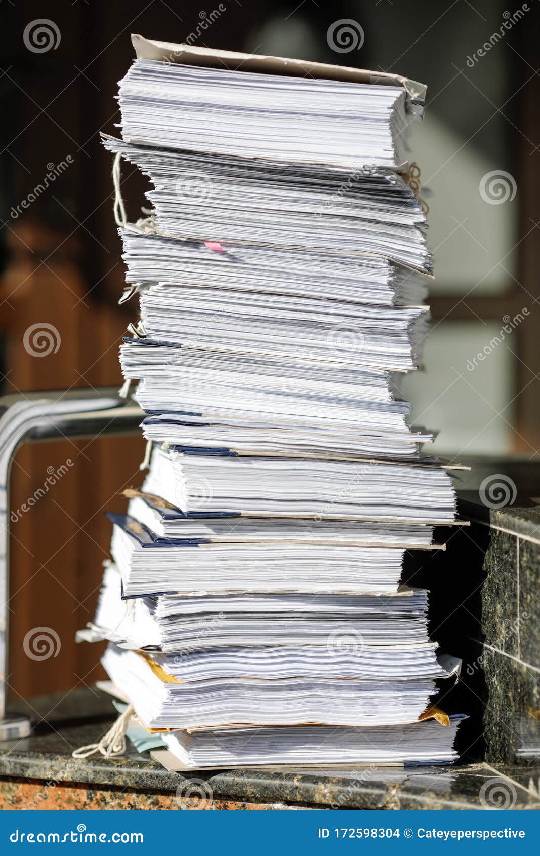 Pile Of Files With A Bookshelf In The Background Royalty-Free Stock ...
