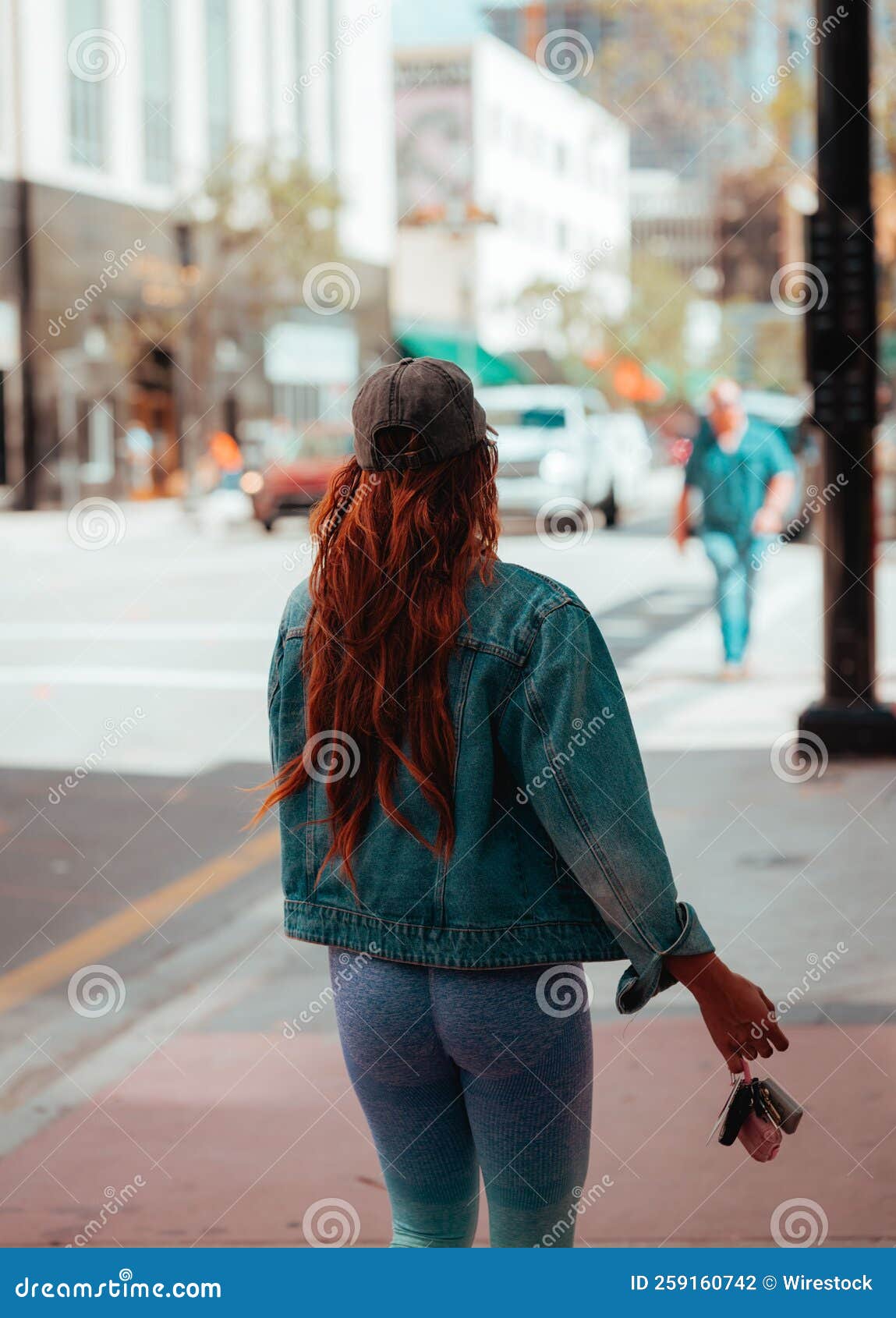 Shallow Focus of a Backside Standing Young Woman in a Sidewalk Stock ...