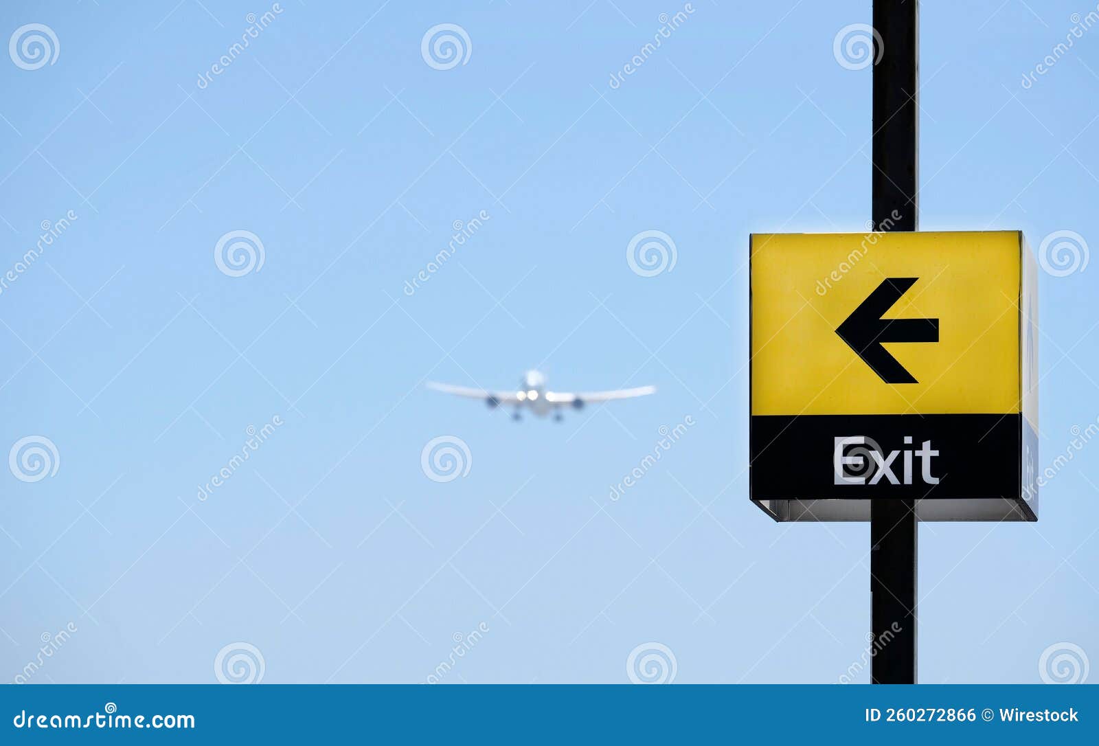 Shallow Focus of a Yellow Exit Sign with a Left Arrow Stock Photo ...