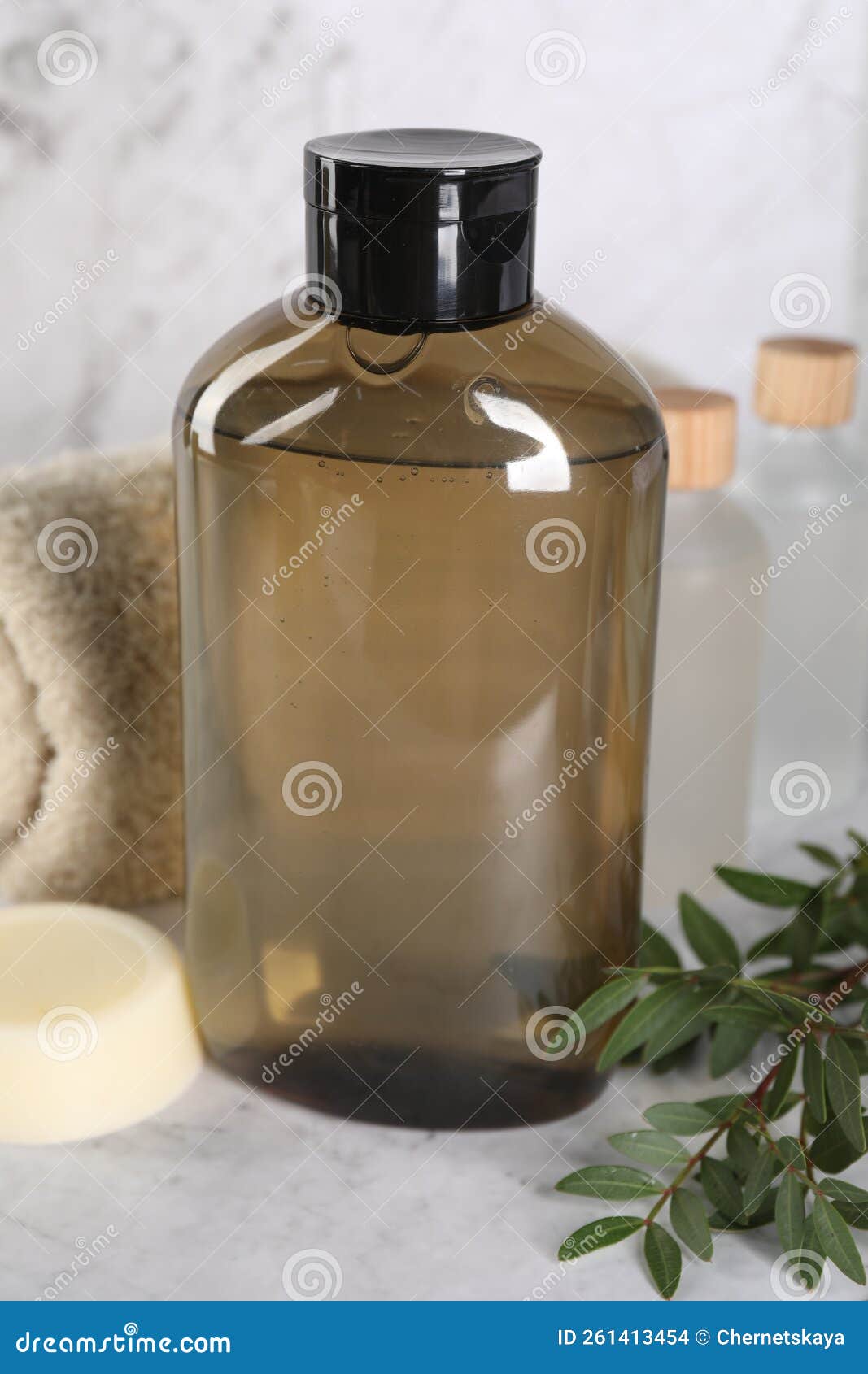 Shampoo Bottle, Essential Oils, Folded Towel and Solid Shampoo Bar on ...