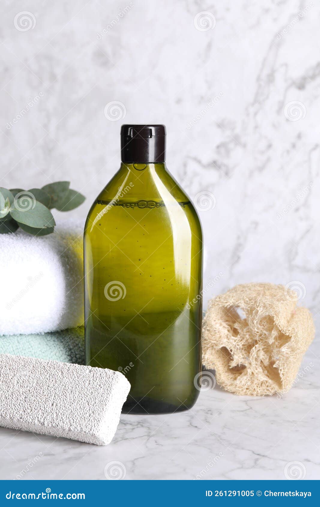 Shampoo Bottle, Loofah, Folded Towels and Pumice on White Marble Table ...