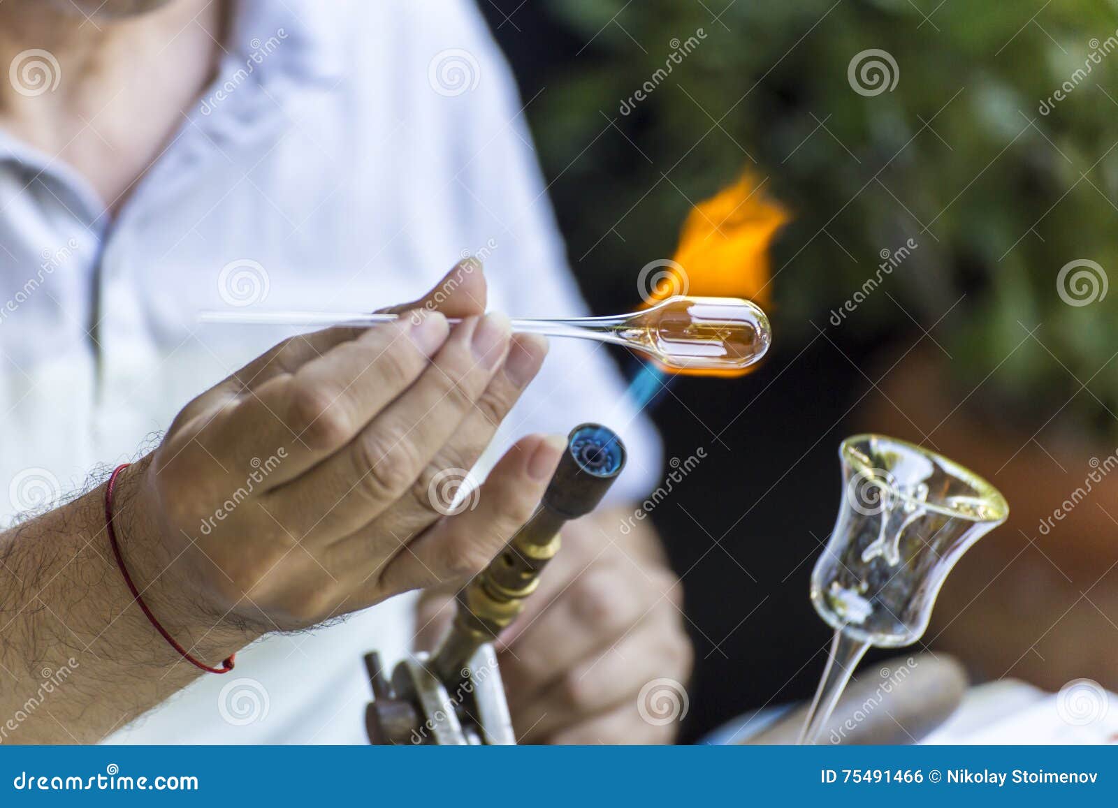 Shaping a piece of glass stock photo. Image of glassblowing - 75491466