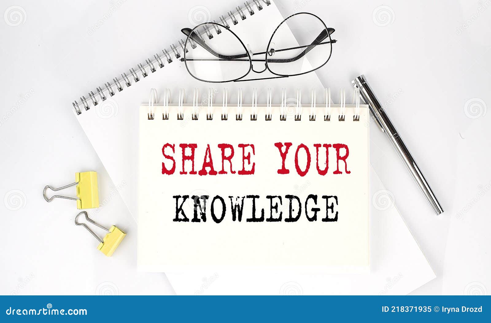 SHARE YOUR KNOWLEDGE Text on the Notebook with Pen,clips and Glasses ...