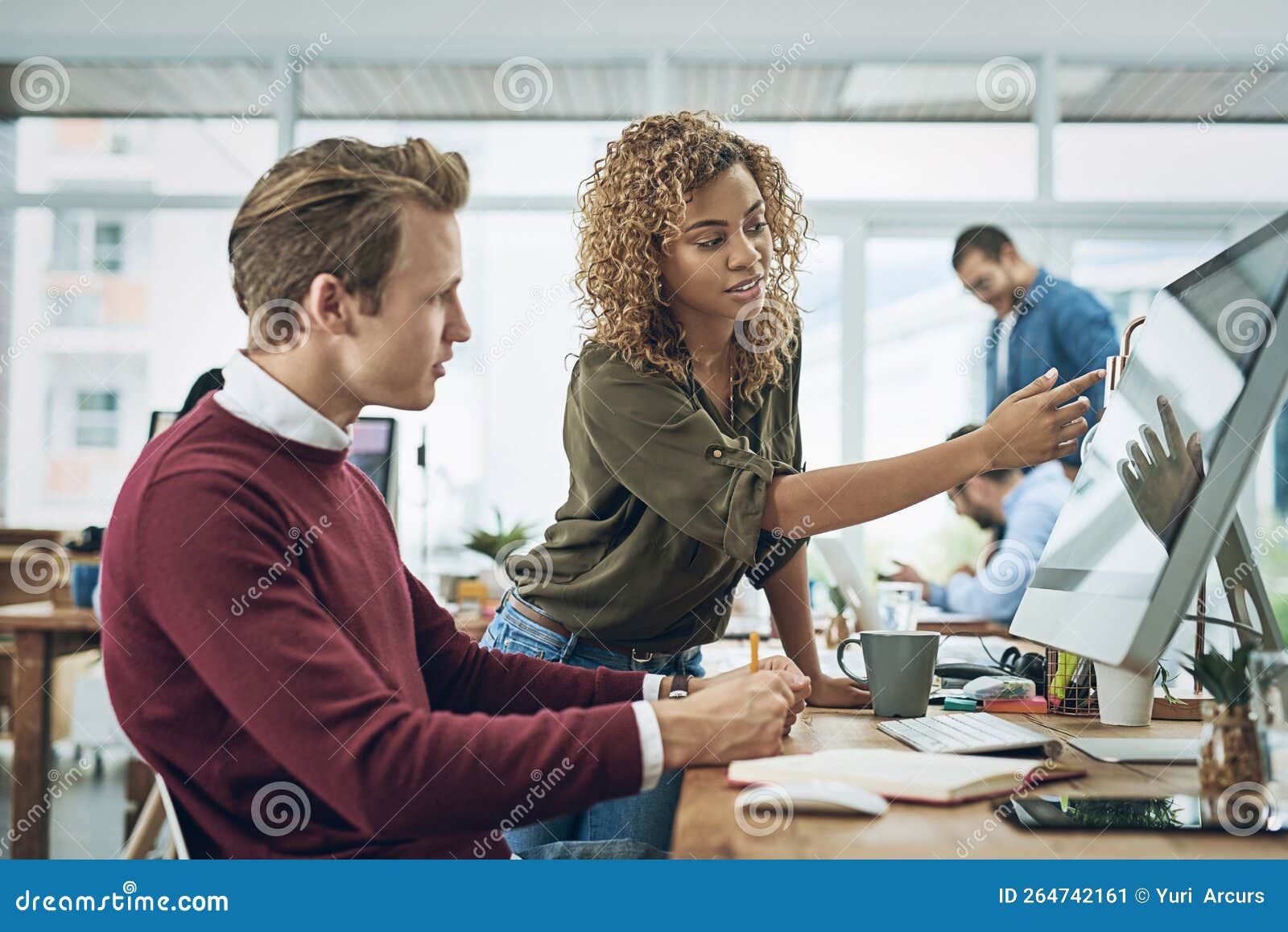 Shared Resources Bring Shared Success. Two Young Colleagues Using a ...