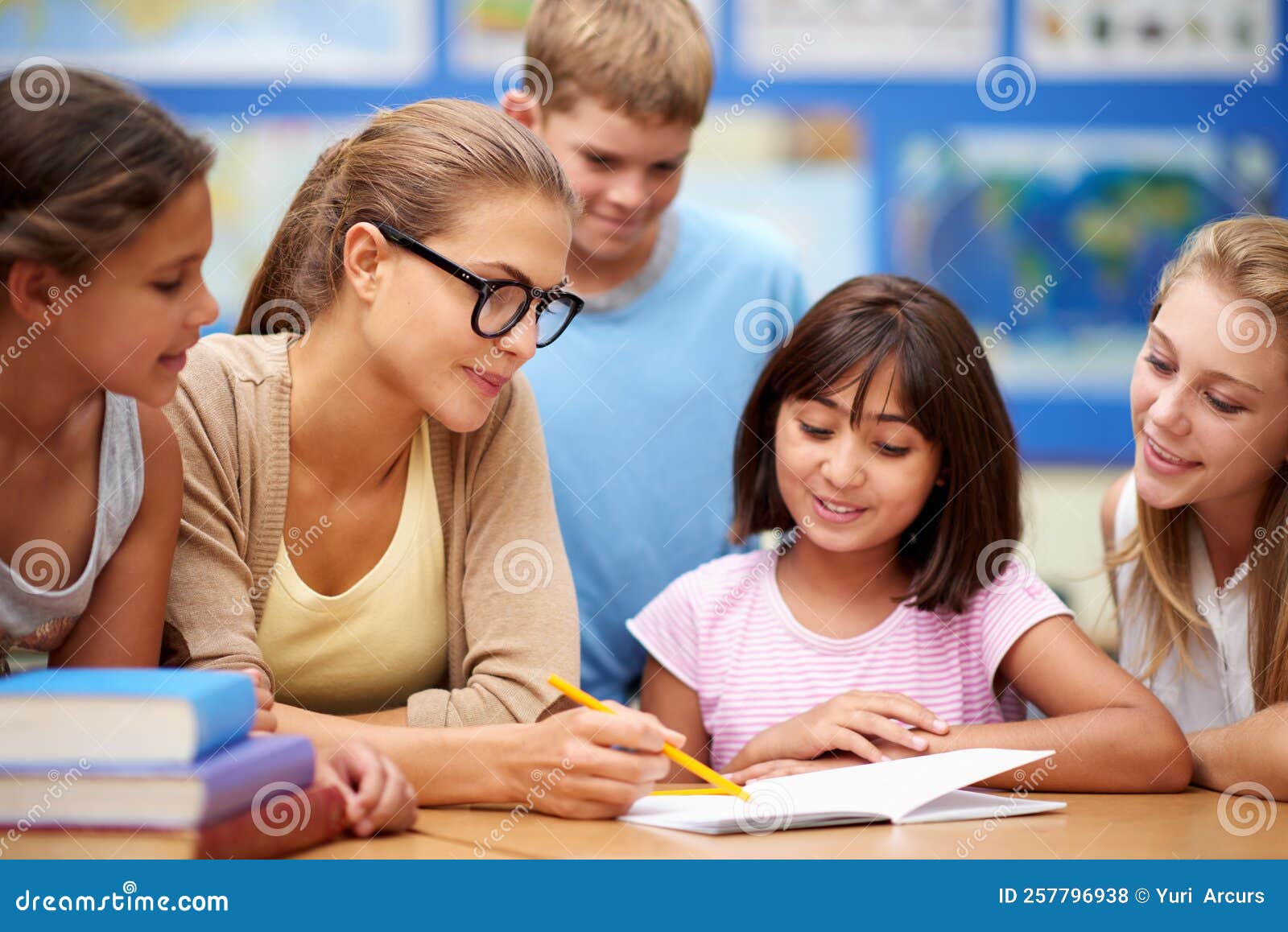 Sharing Her Love of Learning. a Teacher Helping Her Students with Their ...