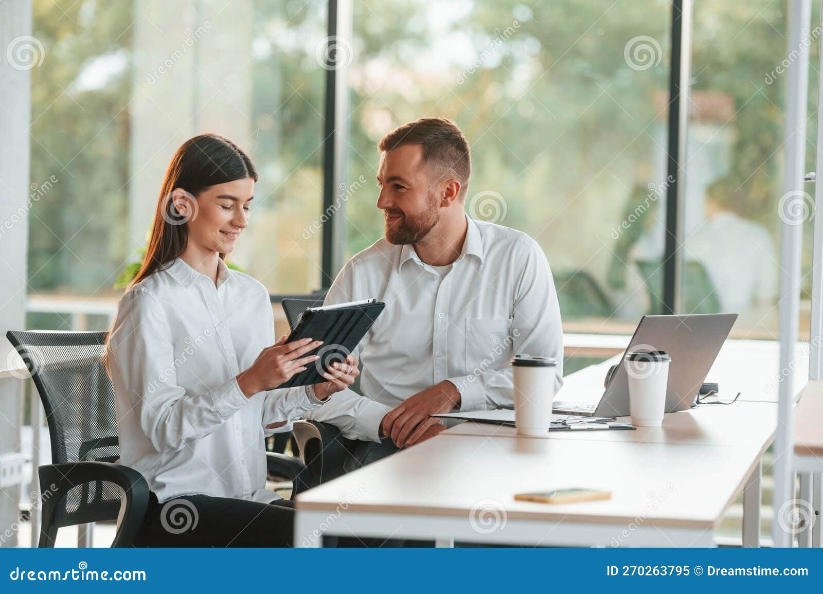 Sharing Ideas. Man and Woman are Working in the Modern Office Together ...
