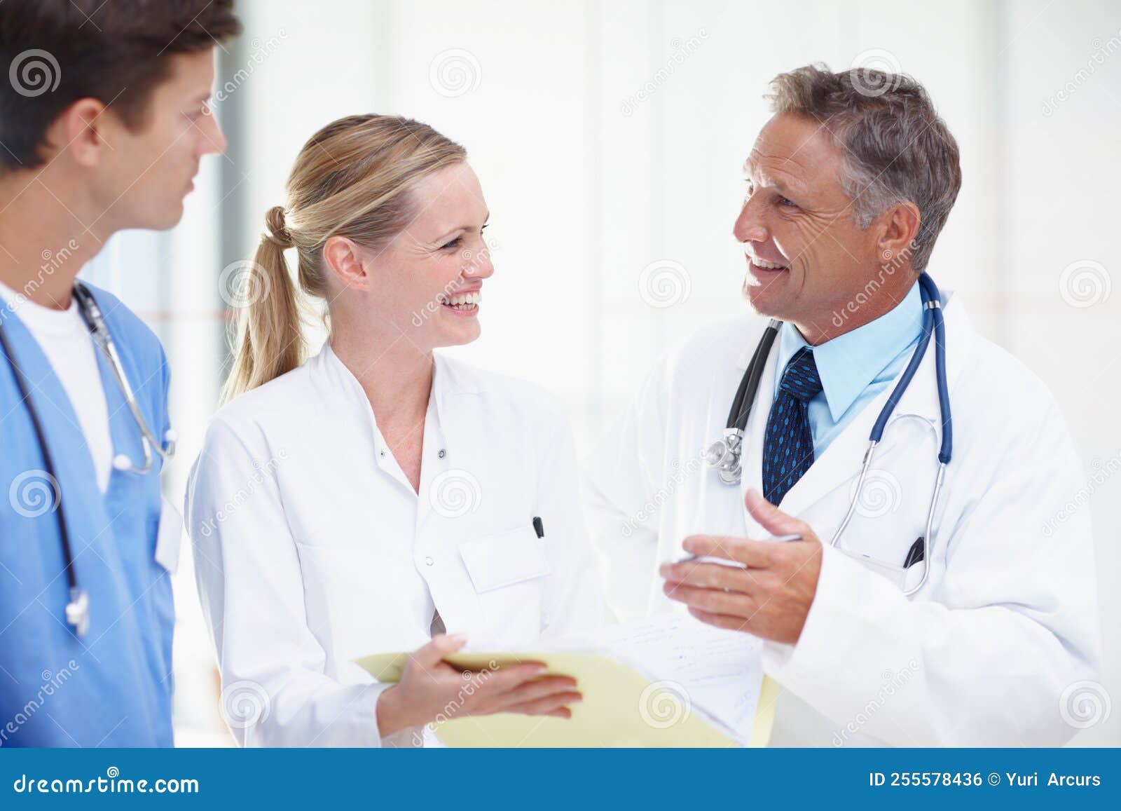 Sharing Ideas on Their Craft. Three Medical Professionals Sharing ...