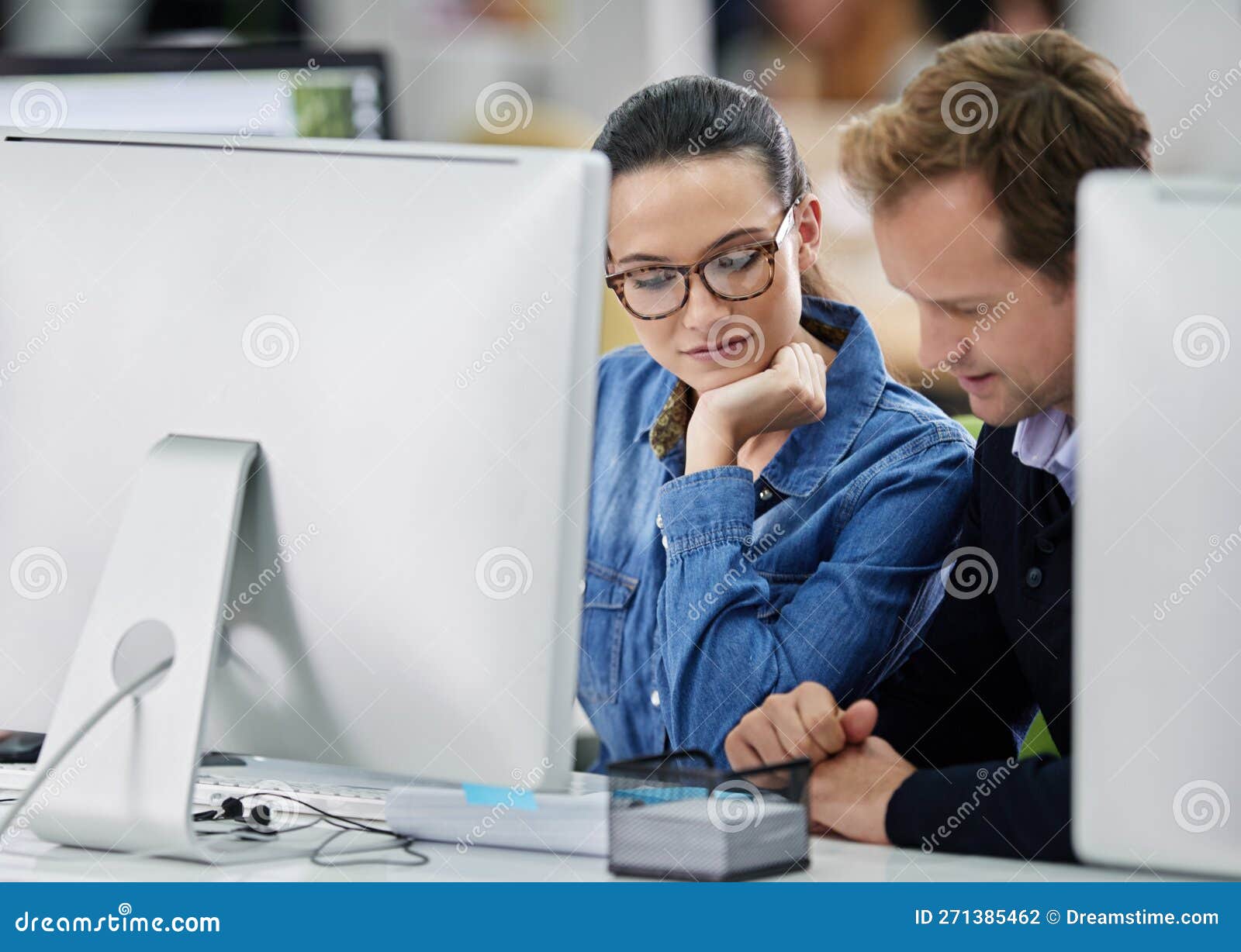 Sharing Knowledge. Coworkers Looking Over Something As Seen between ...