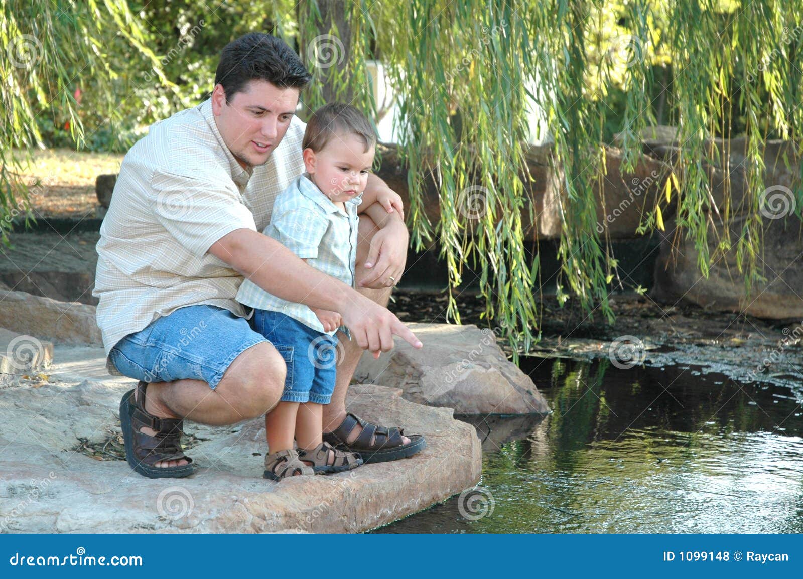 Sharing Life stock photo. Image of arms, blue, daddy, boulder - 1099148