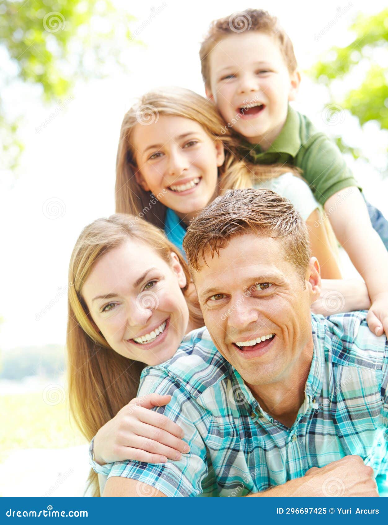 Sharing Matching Smiles. a Happy Young Family Relaxing Together on a ... Sharing Matching Smiles. a Happy Young Family Relaxing Together on a ...