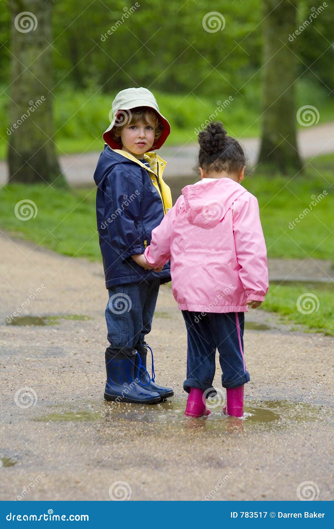 Sharing a Puddle stock image. Image of paddle, girl, cousins - 783517
